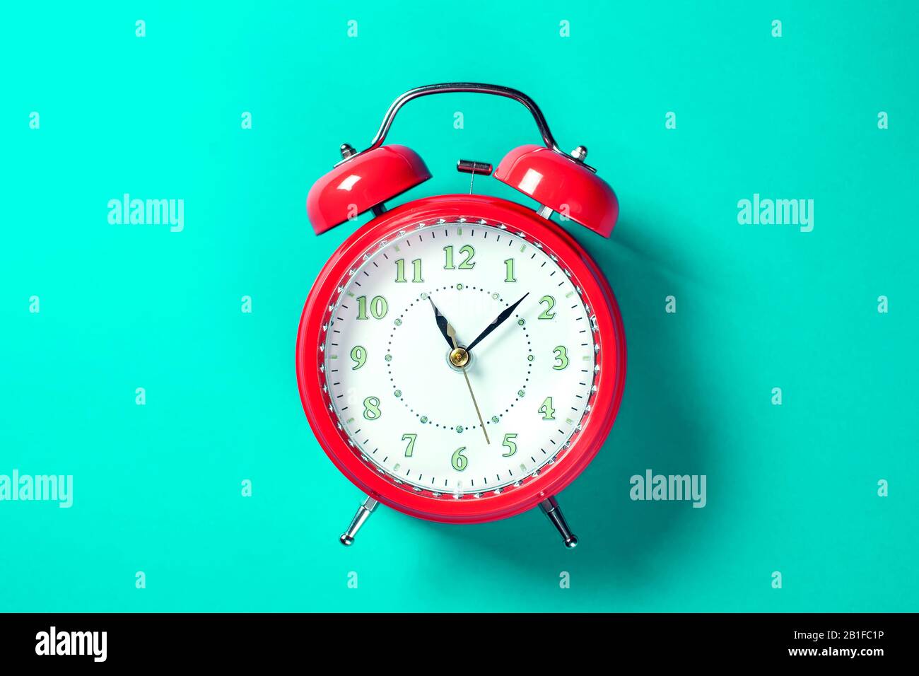 Red alarm clock on the color background Stock Photo - Alamy