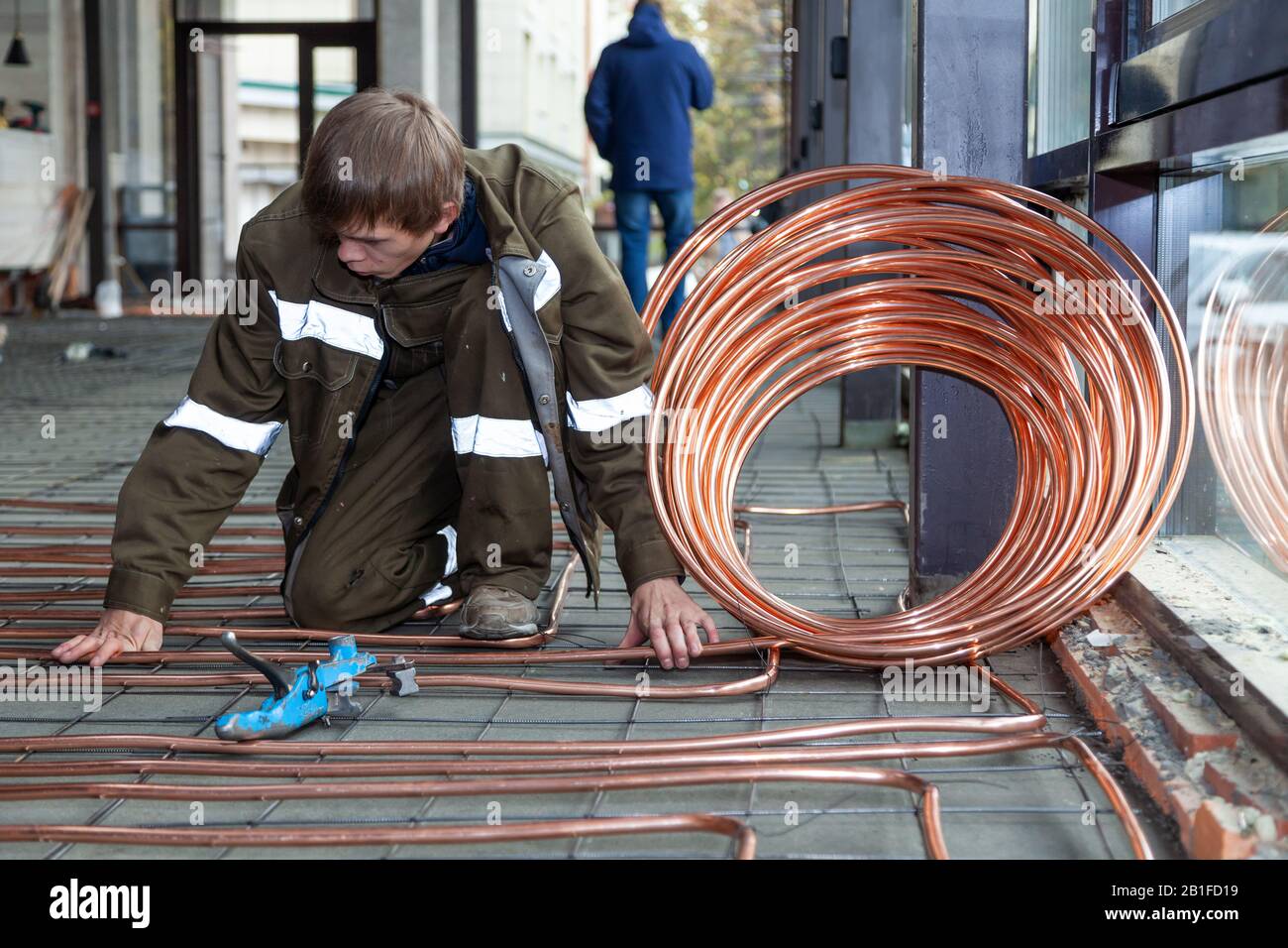 Russia Kemerovo 2020-09-27 Male plumber worker in uniform holds large ...