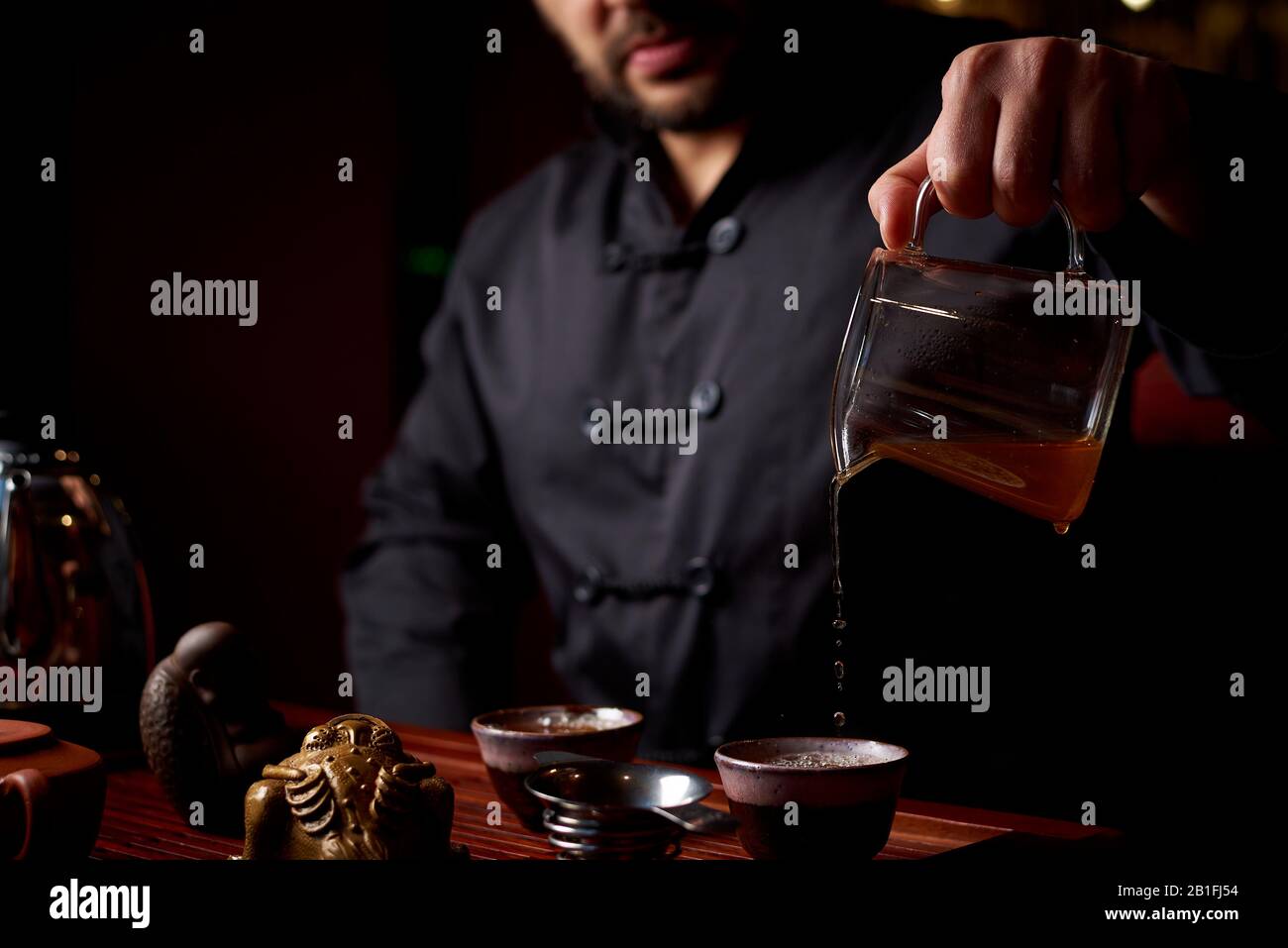 Hand pours tea from traditional hi-res stock photography and images - Alamy