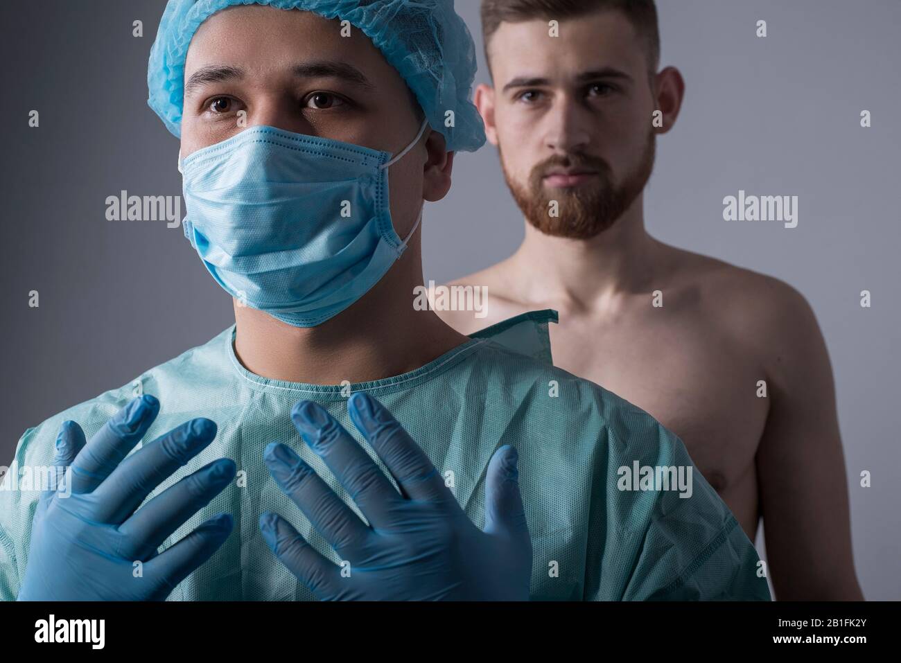 closeup portrait in focus of an asian surgeon in medical mask and ...