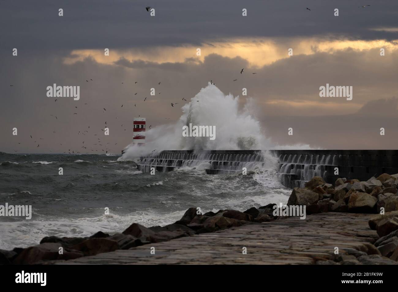 Dramatic stormy winter sunset at the Douro river mouth with big wave ...