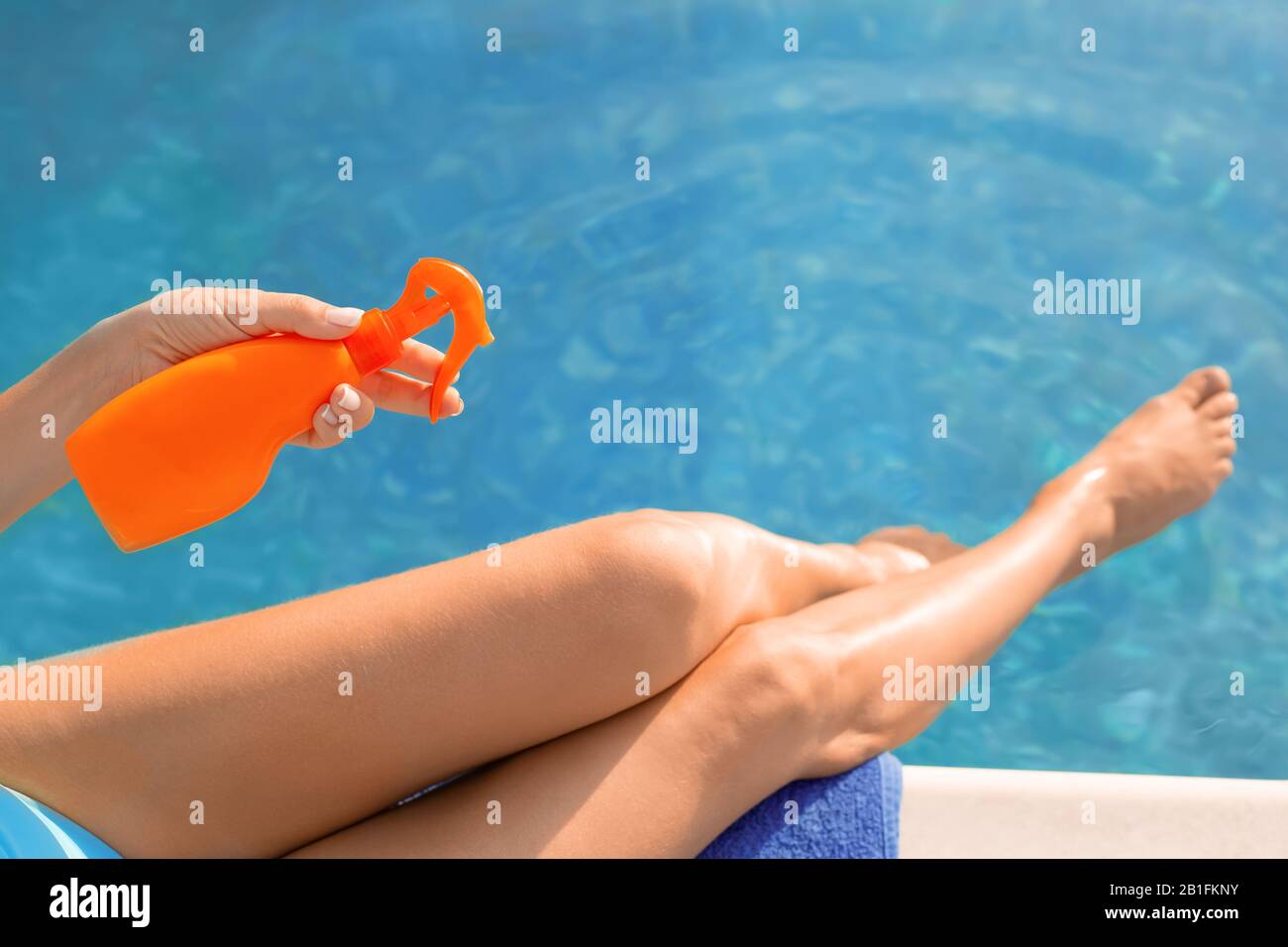 Cosmetic Sunscreen Product Applying On Woman Slim Legs Near Pool In