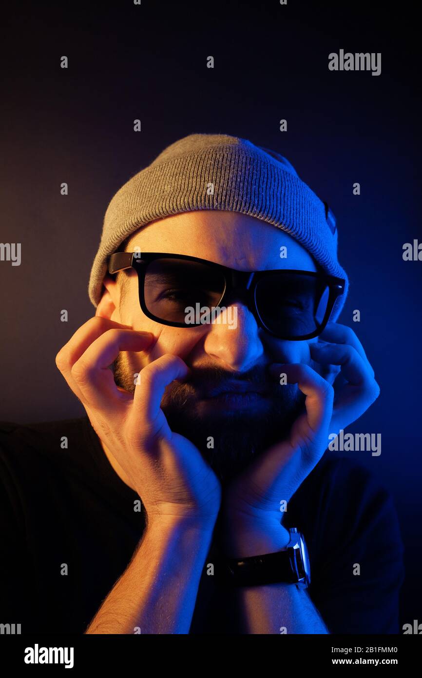 Portrait of a hipster guy with color light. Hipster face portrait in ...