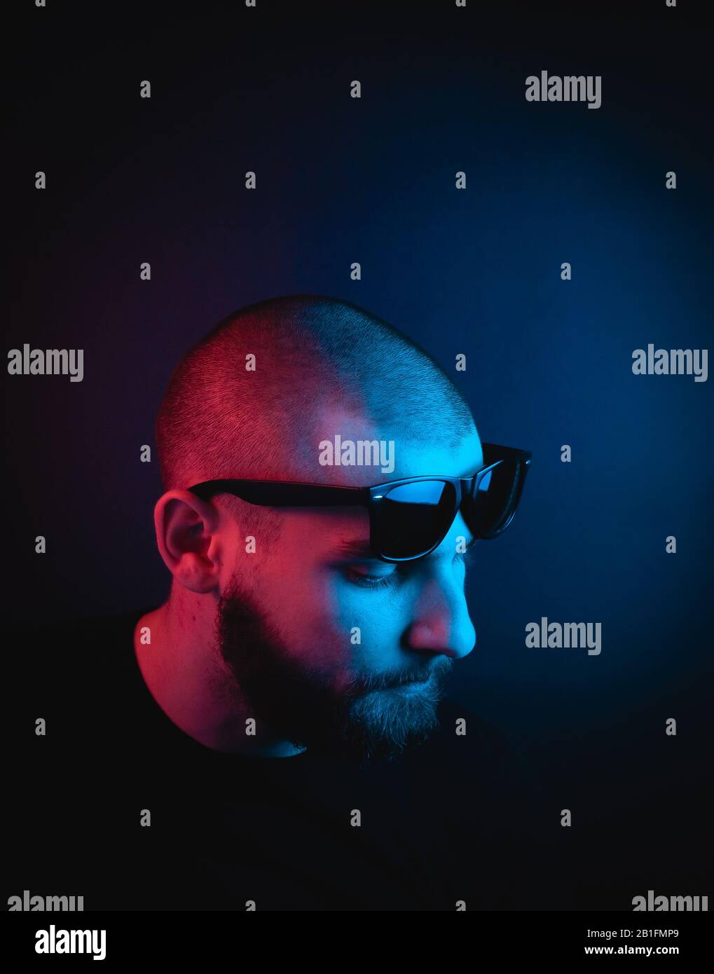 Portrait of a hipster guy with color light. Hipster face portrait in ...