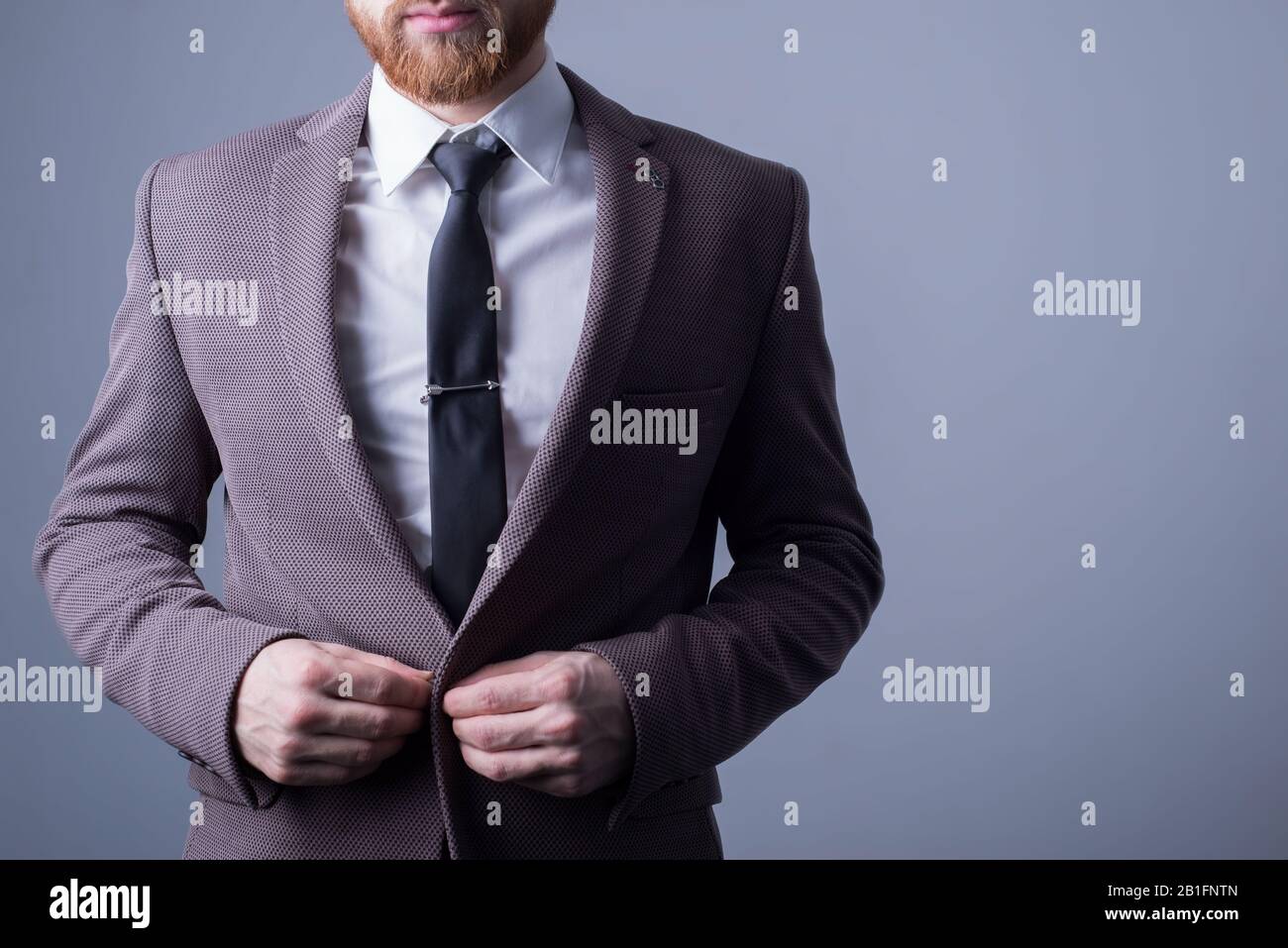studio portrait of a young bearded handsome guy of twenty-five years ...