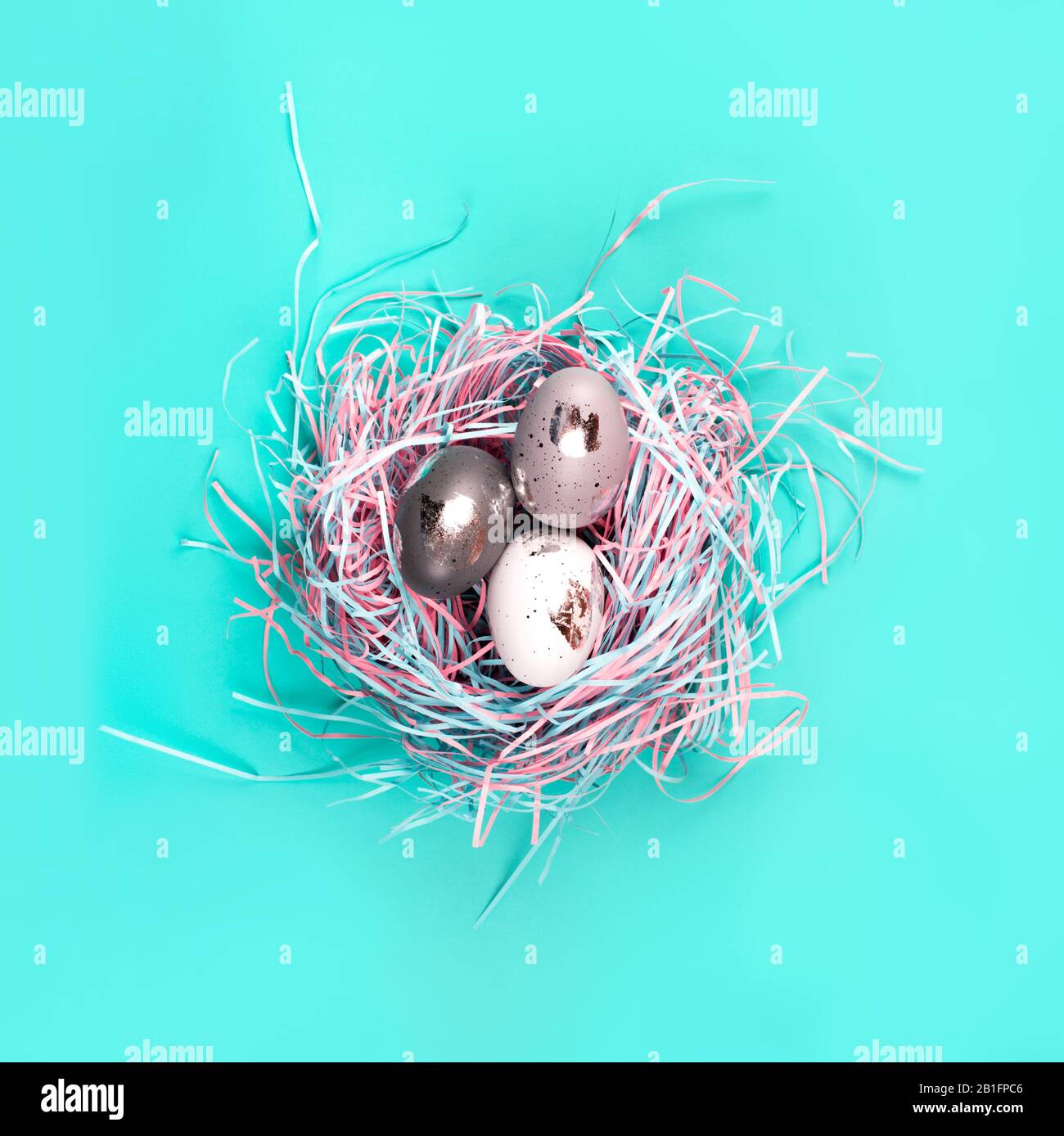 Decorative bird nest with creative hand-painted silver eggs on blue ...