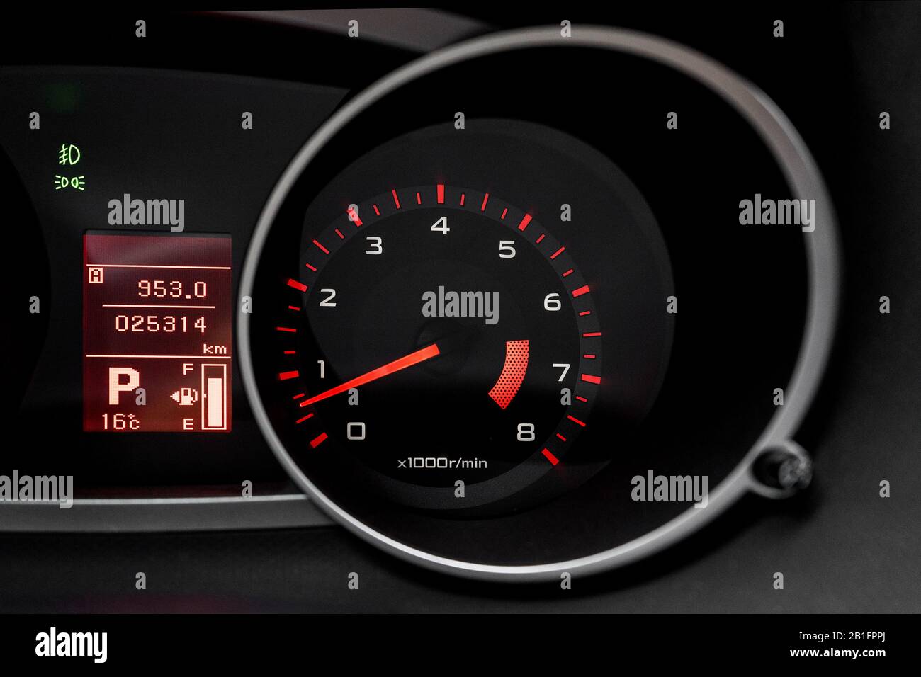 Car dashboard with speedometer and illuminated fuel consumption ...