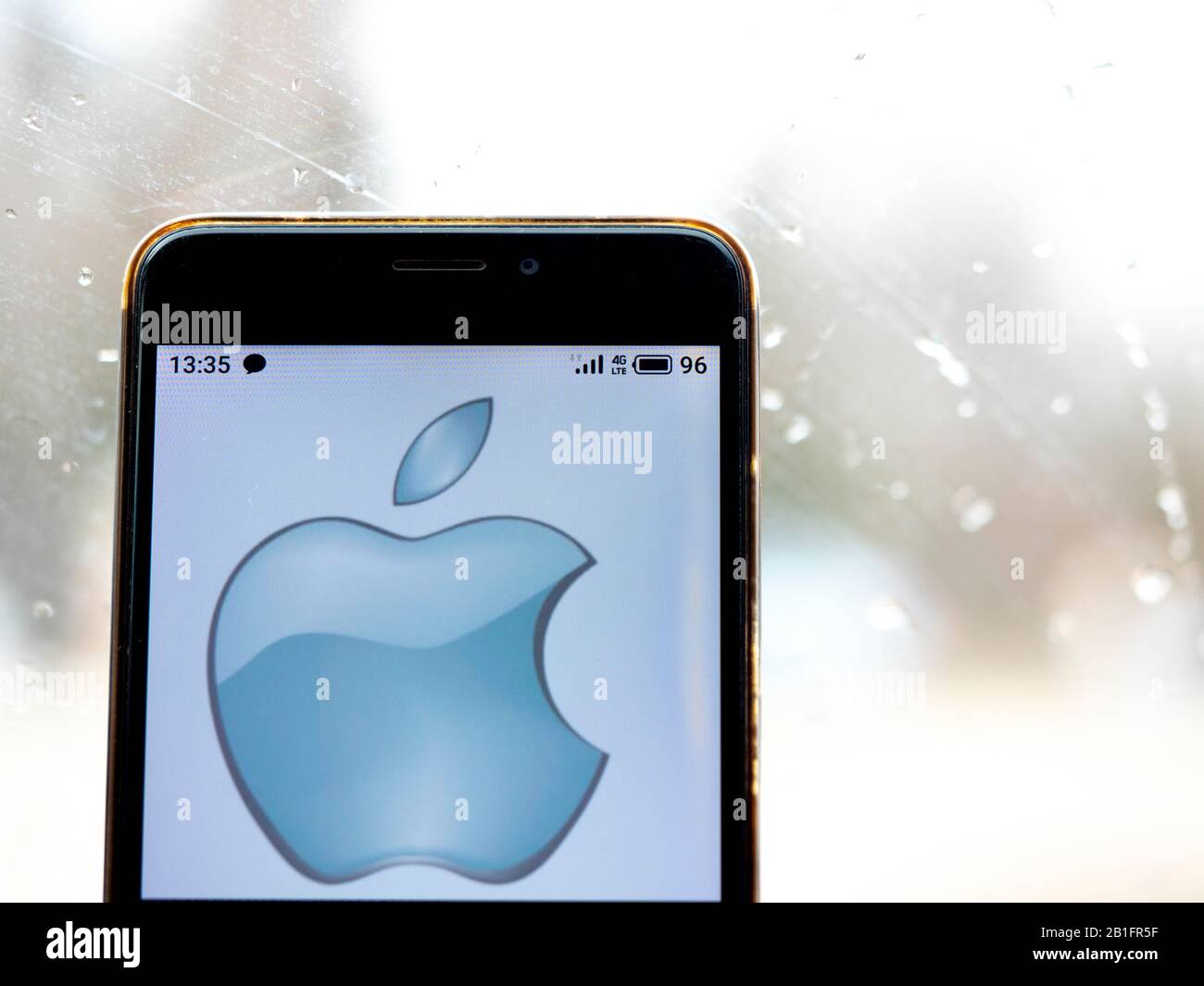 In this photo illustration the Apple logo is seen displayed on a ...