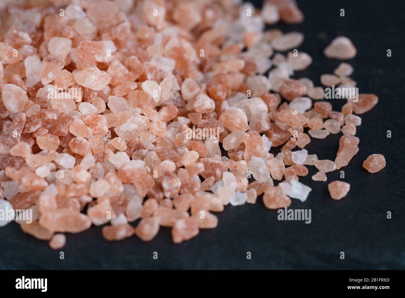 Pink Himalayan salt on slate plate. Black background, high resolution ...