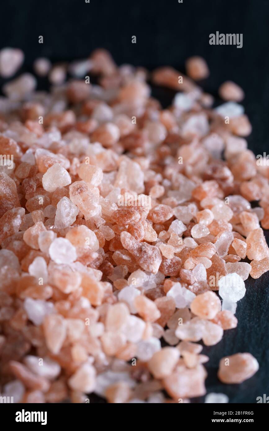 Pink Himalayan salt on slate plate. Black background, high resolution ...