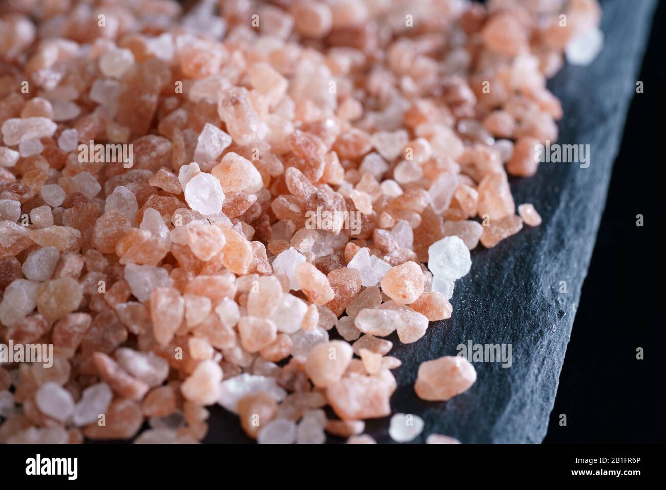 Pink Himalayan salt on slate plate. Black background, high resolution ...