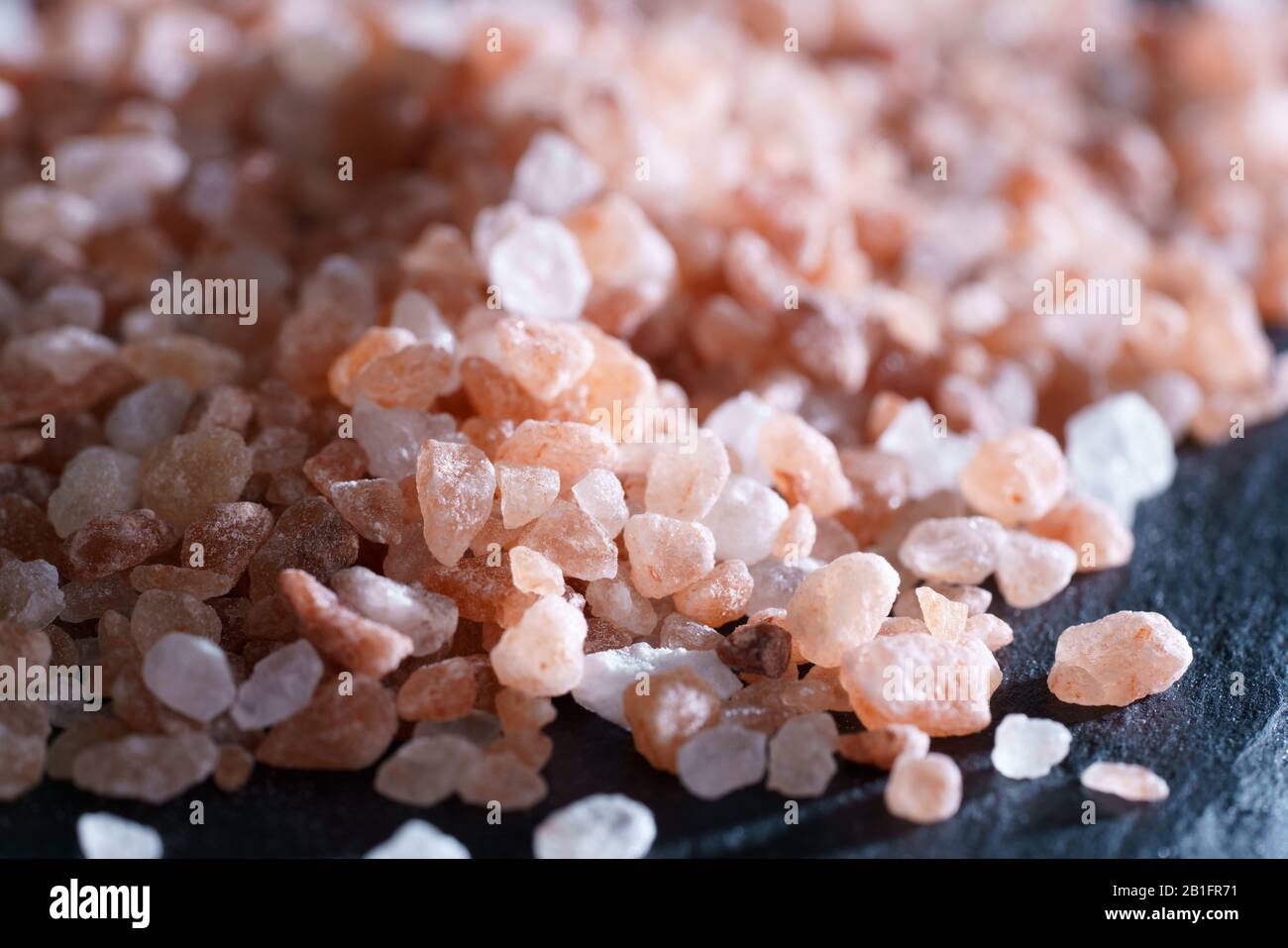 Pink Himalayan salt on slate plate. Black background, high resolution ...