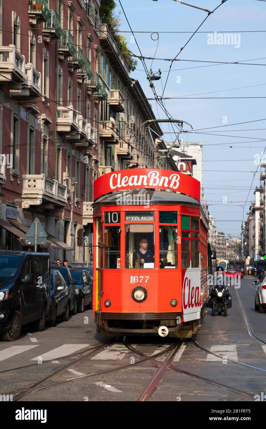 A colourful red electric tram in Milan, Lombardy, Italy, Europe Stock ...