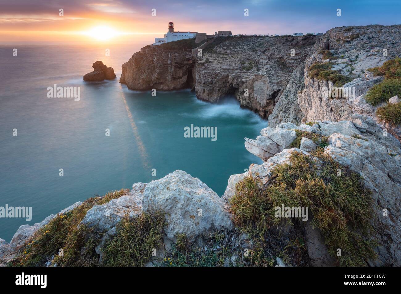 The cliffs and lighthouse of Cabo De San Vicente at sunset, overlooking ...