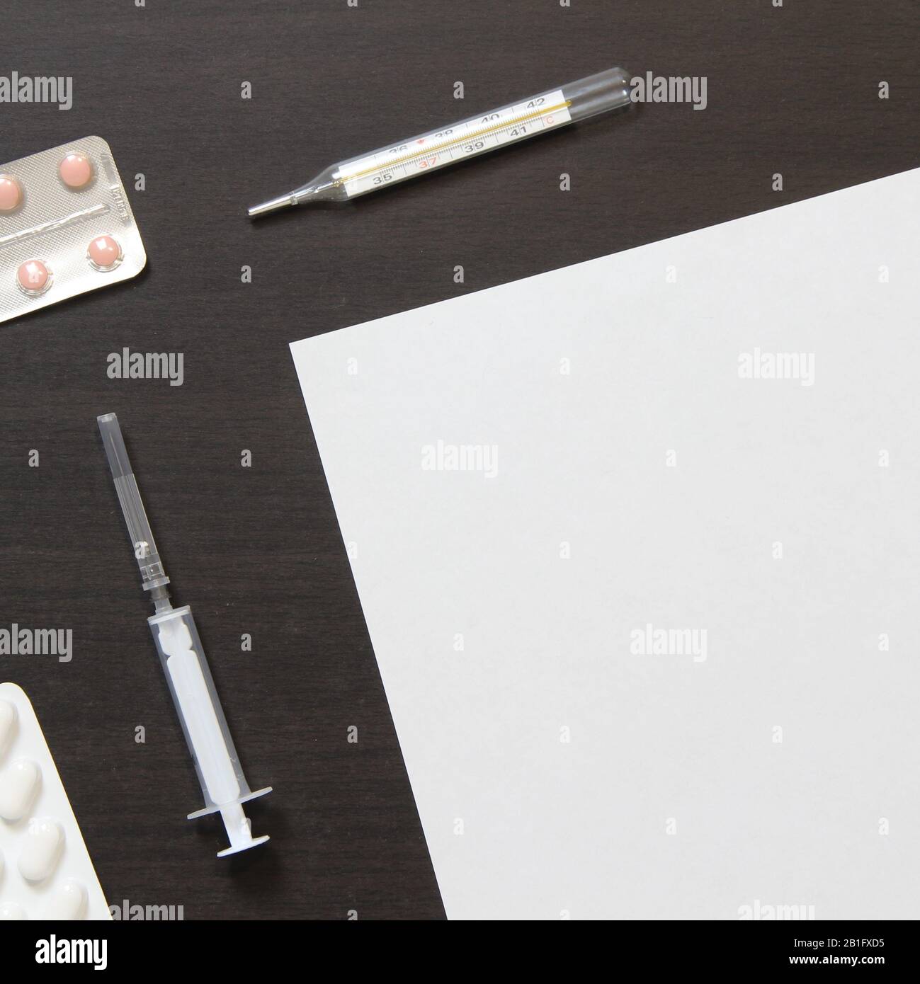 Template of white paper with pills in a blister, thermometer and ...