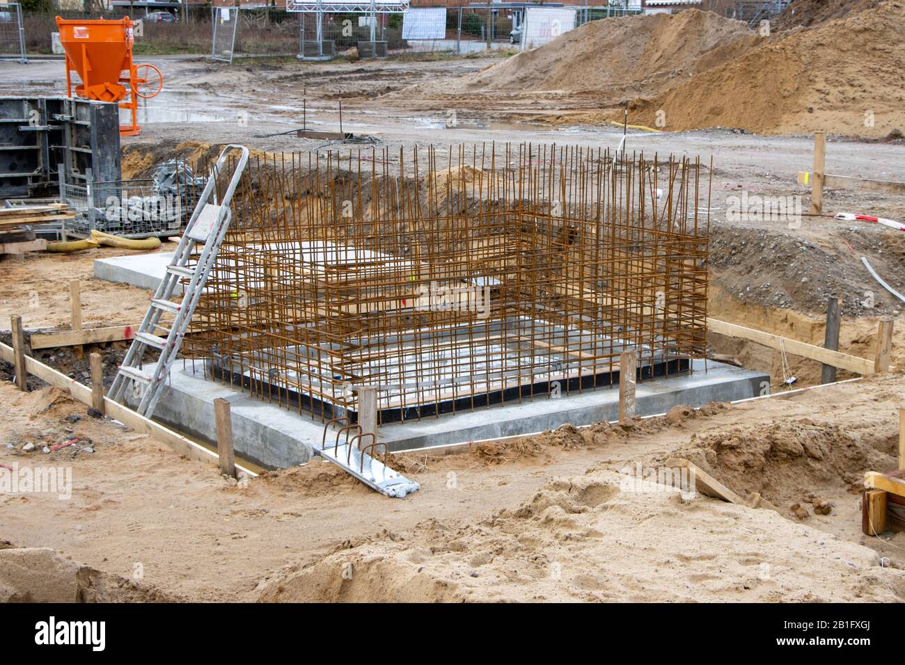 The concrete foundations for the columns of a factory building are ...
