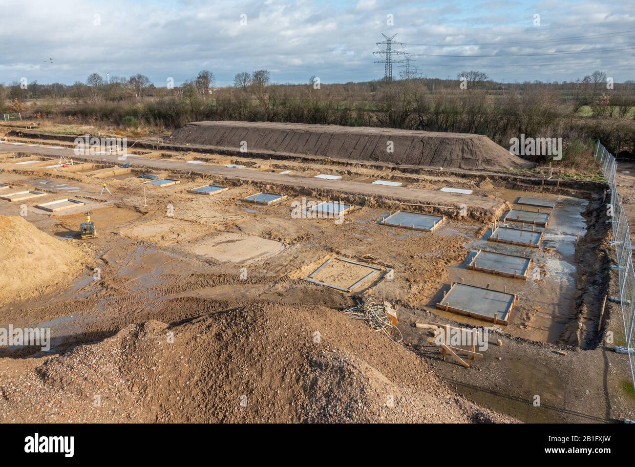 The concrete foundations for the columns of a factory building are ...