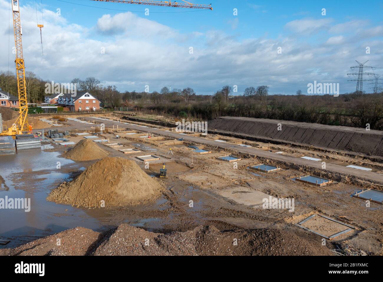 The concrete foundations for the columns of a factory building are ...