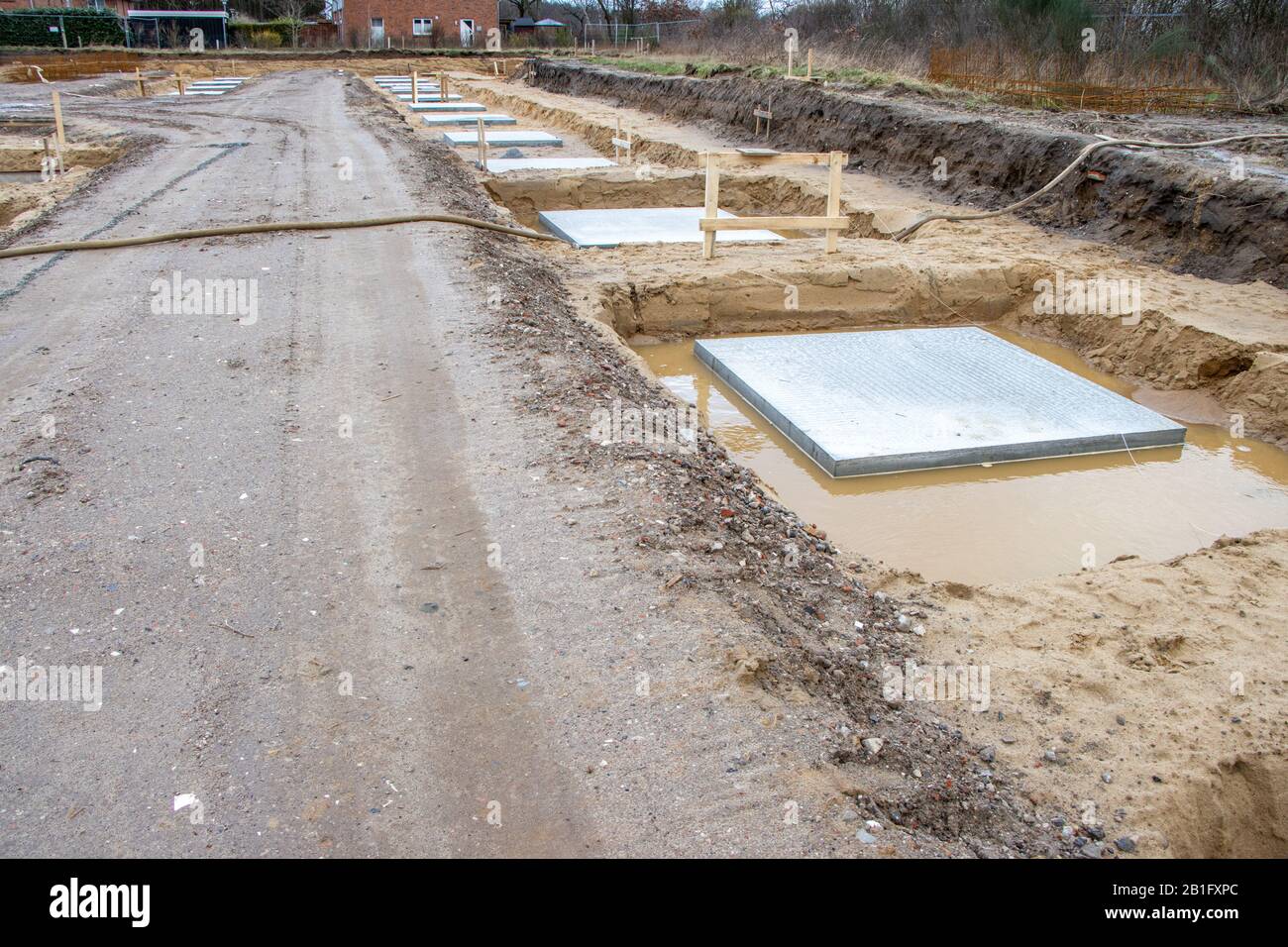 The concrete foundations for the columns of a factory building are ...