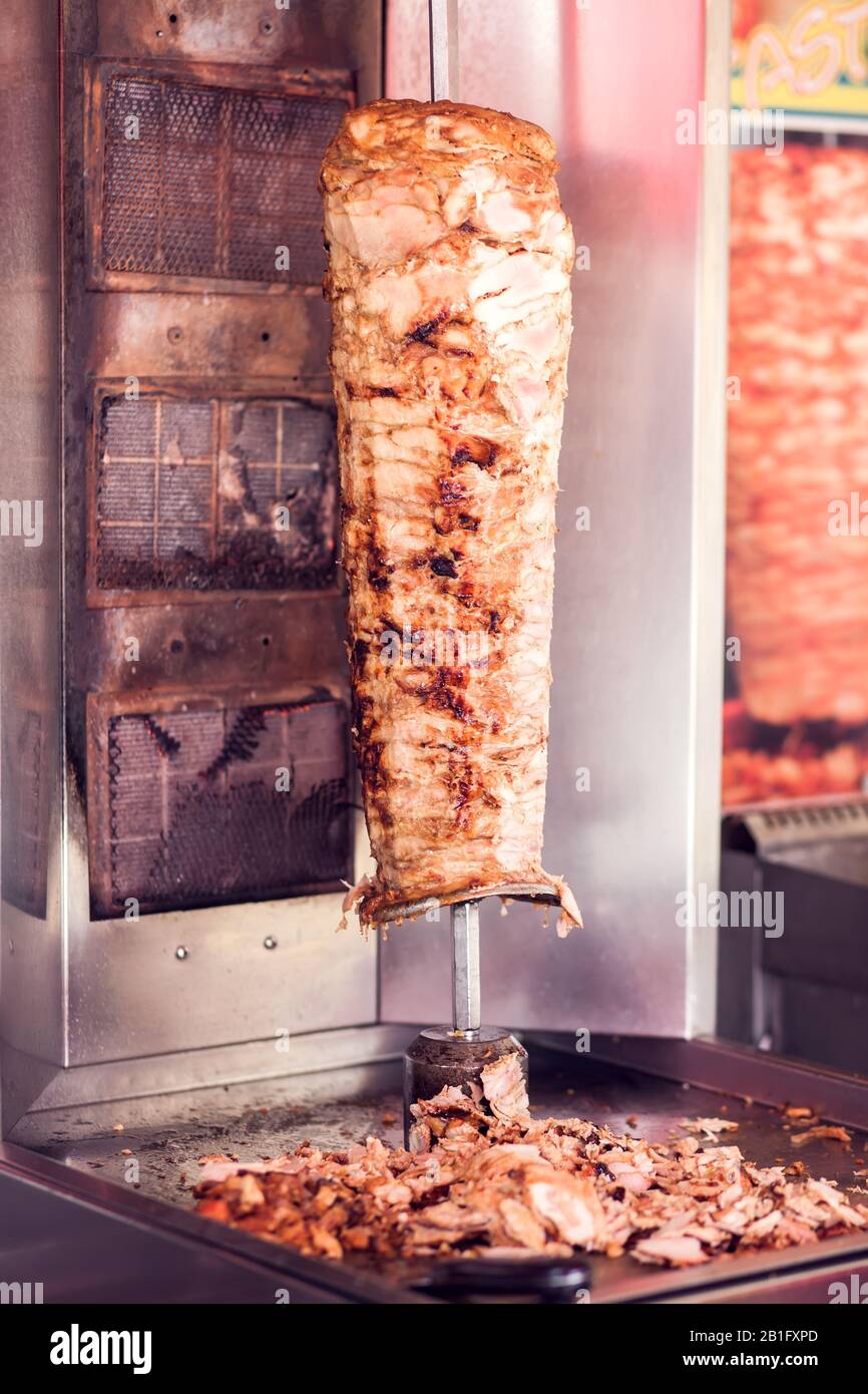 A cook cutting kebab meat with knife at fast food cafe Stock Photo - Alamy