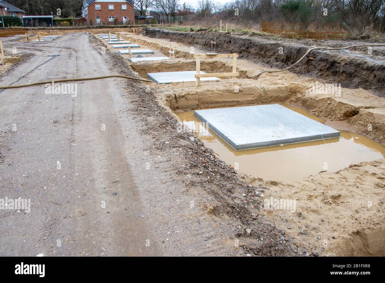The concrete foundations for the columns of a factory building are ...