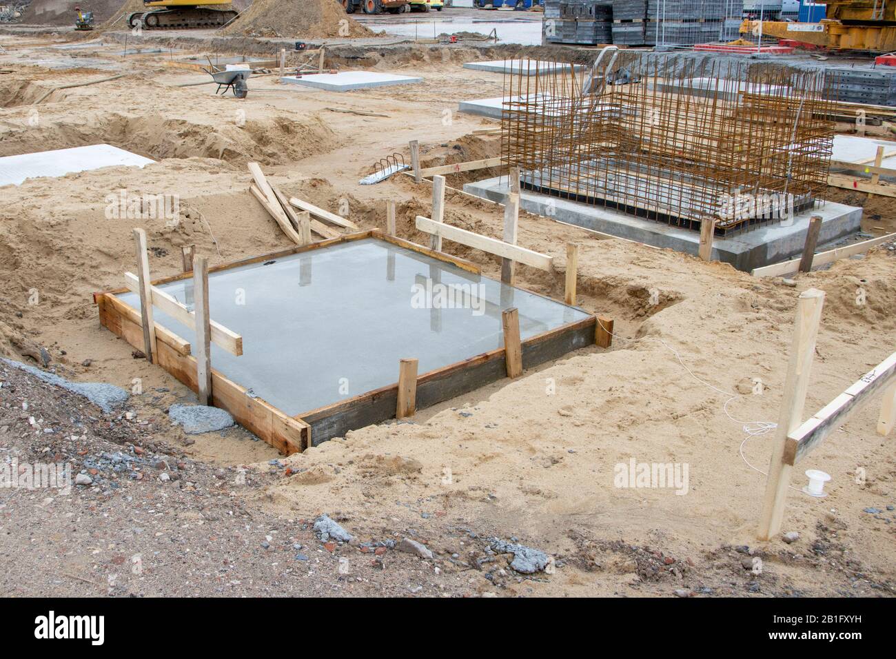 The concrete foundations for the columns of a factory building are ...