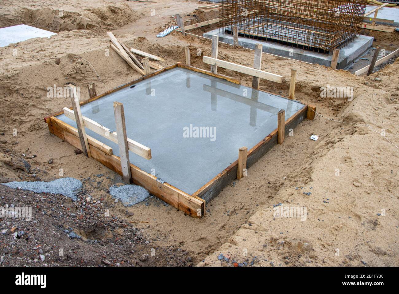 The concrete foundations for the columns of a factory building are ...