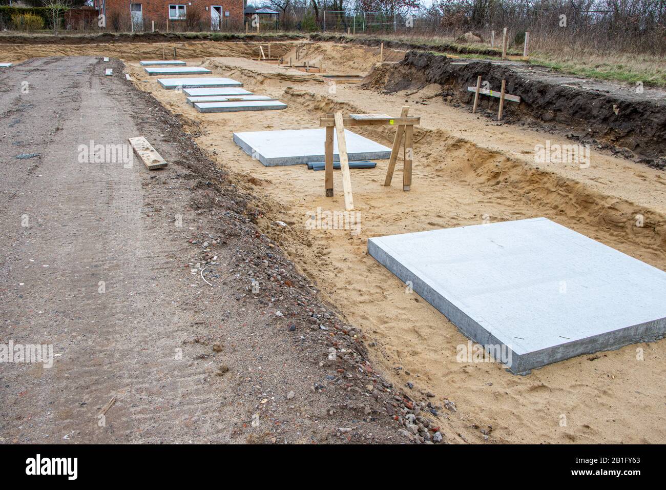 The concrete foundations for the columns of a factory building are ...