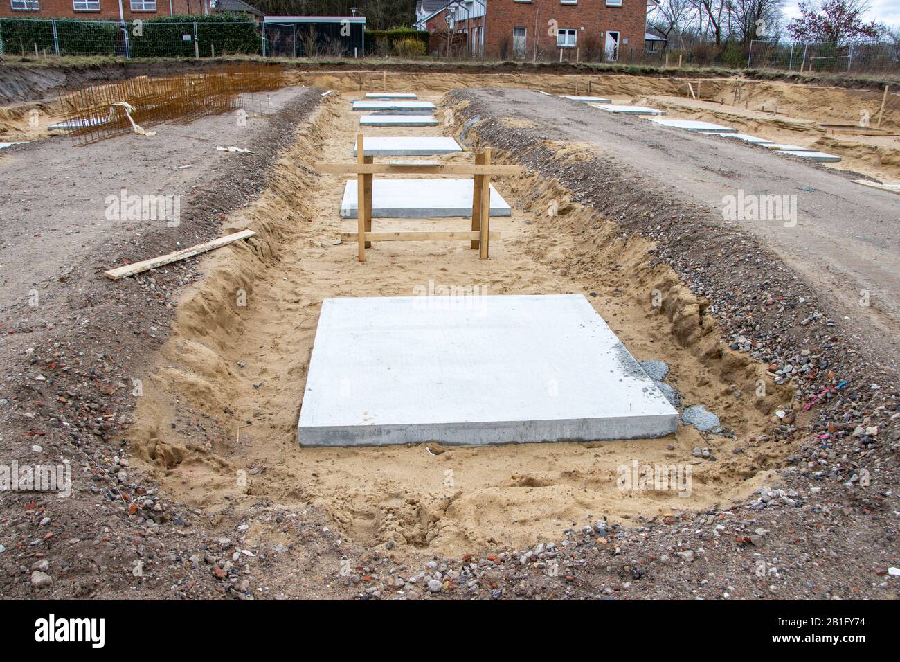 The concrete foundations for the columns of a factory building are ...