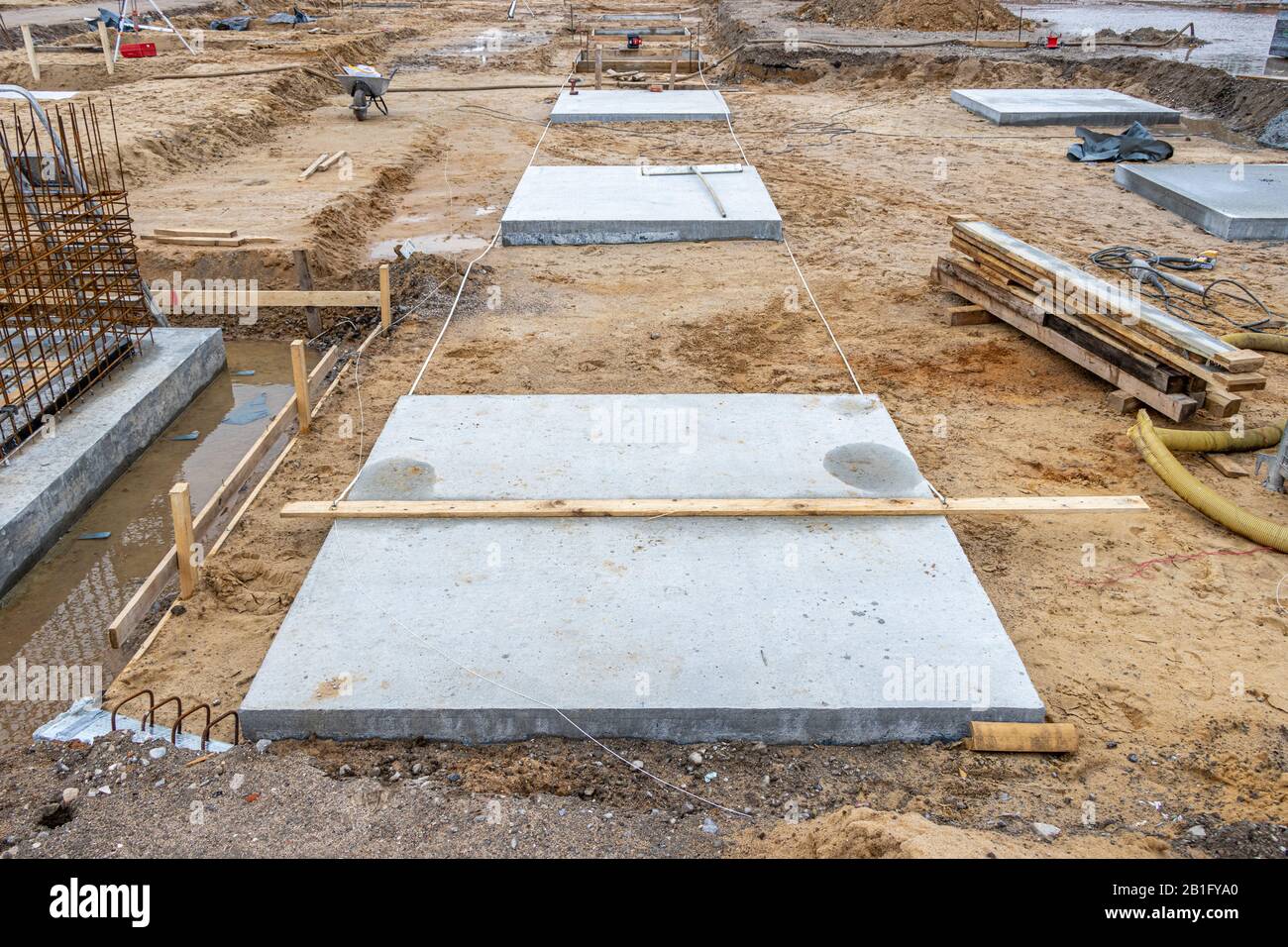 The concrete foundations for the columns of a factory building are ...
