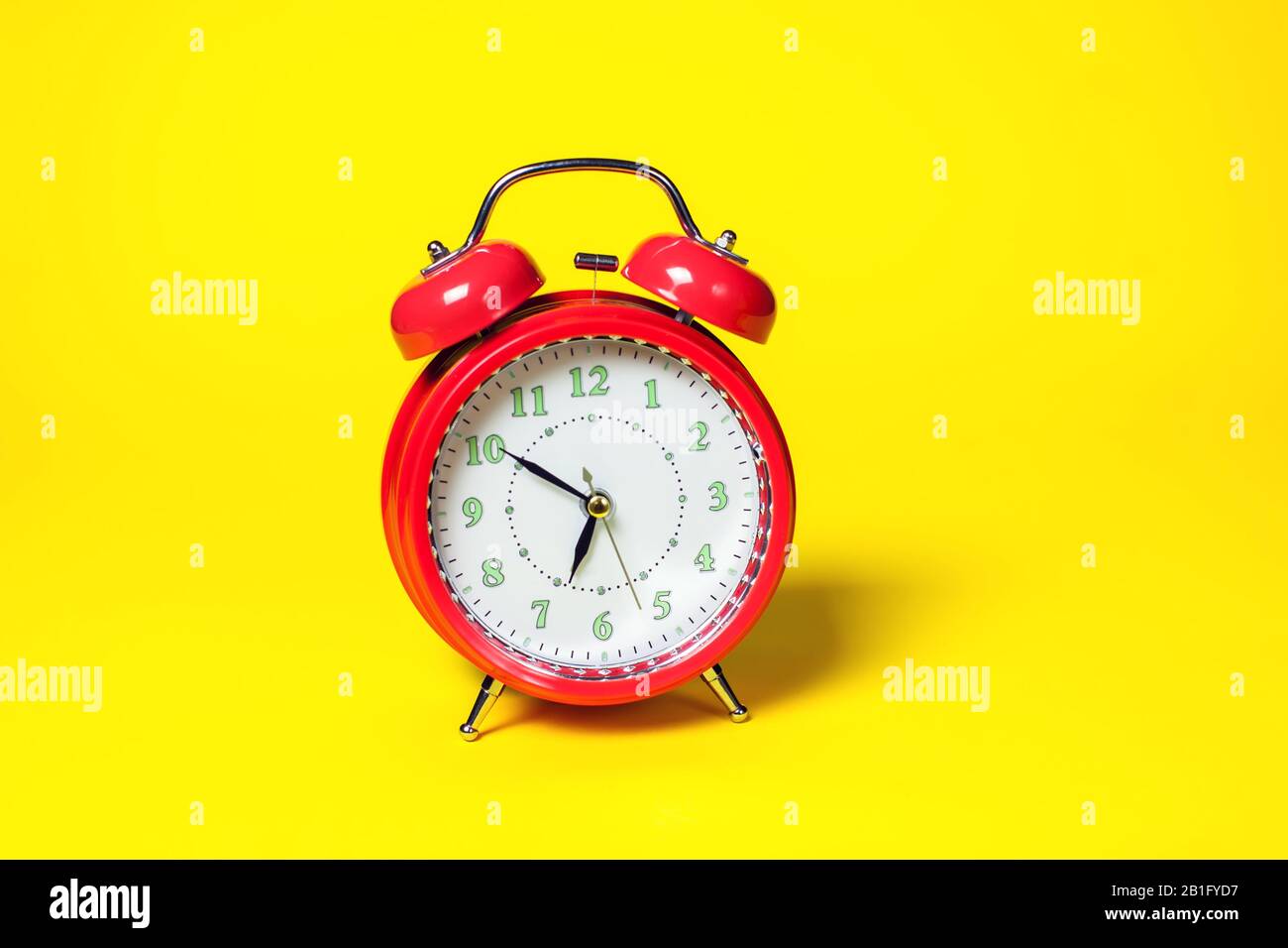 Red alarm clock is on color background. Time concept Stock Photo - Alamy