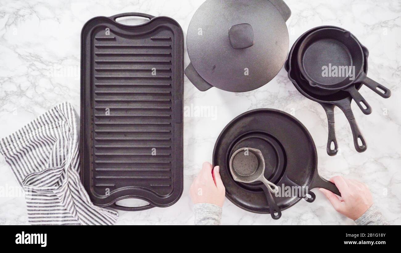 Flat lay. Variety of cast iron kitchenware on a marble countertop Stock ...