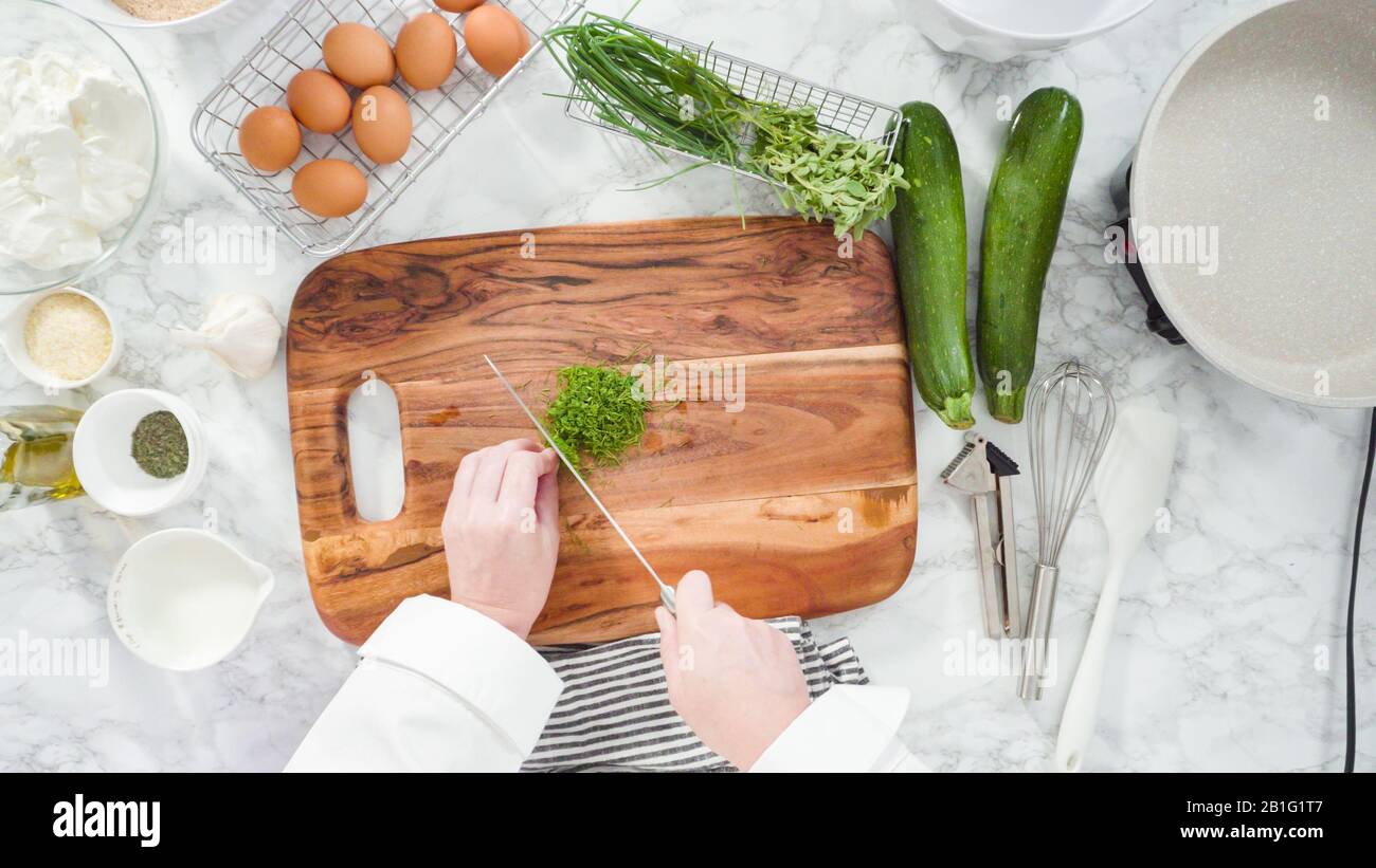 Flat lay. Step by step. Cutting ingredients to make zucchini cakes with ...