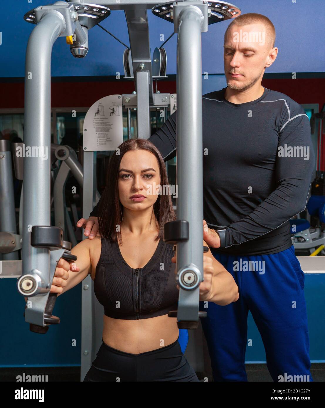personal trainer man working with young woman in modern gym Stock Photo ...