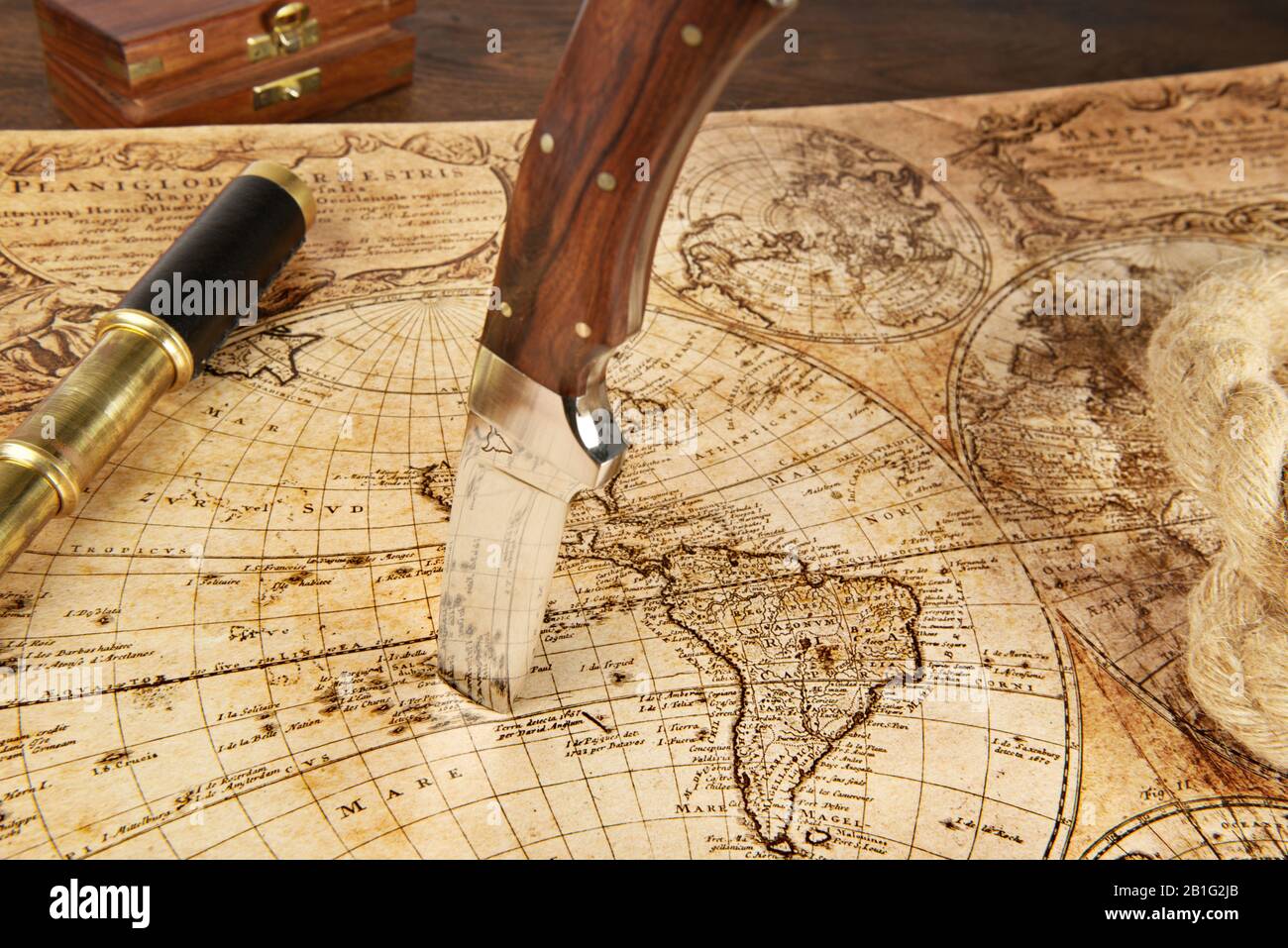 Knife sticking in a old Map to locate the Treasure Stock Photo - Alamy
