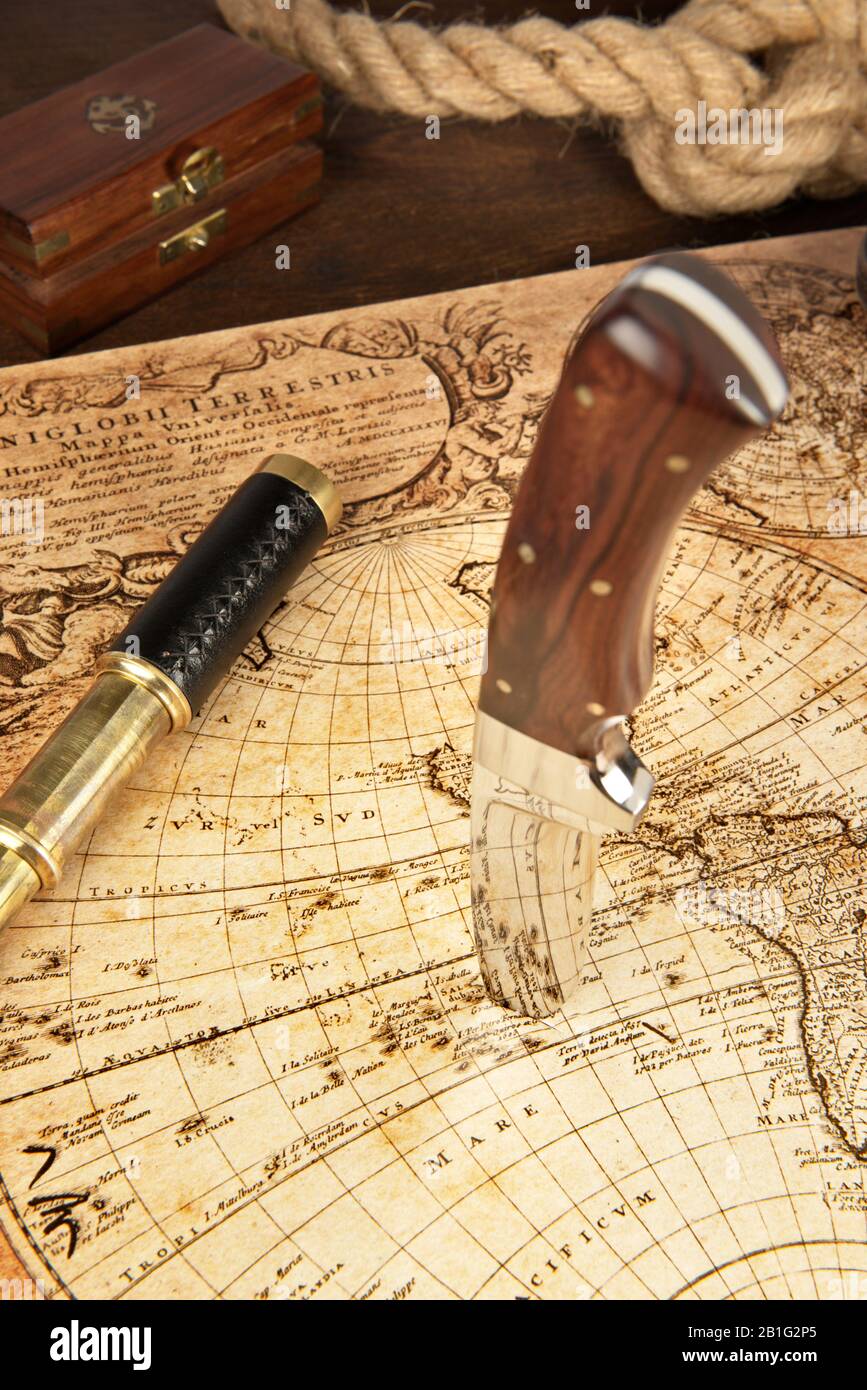 Knife sticking in a old Map to locate the Treasure Stock Photo - Alamy
