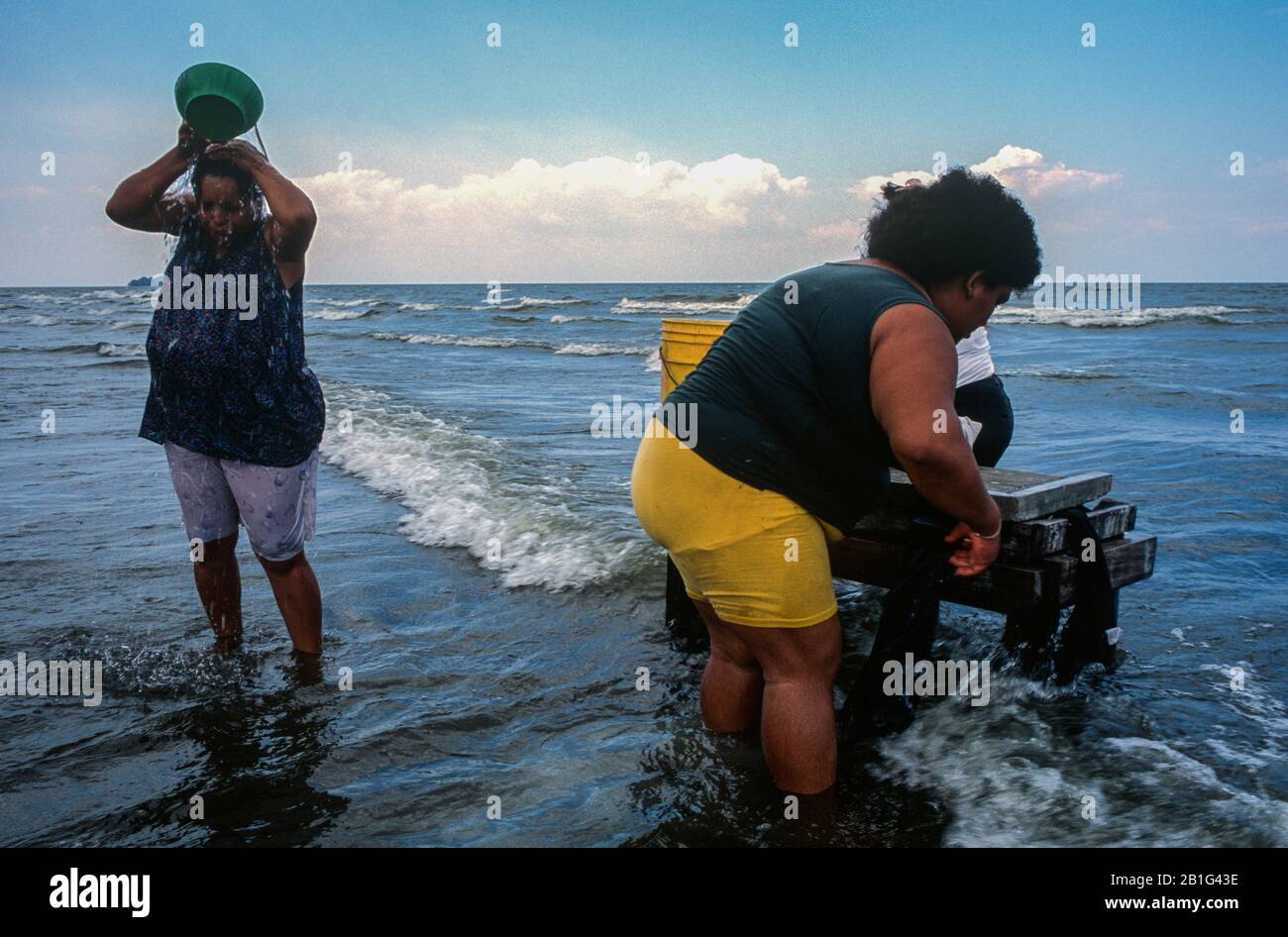 Three women bathe and wash their clothes in Lake Nicaragua Stock Photo ...