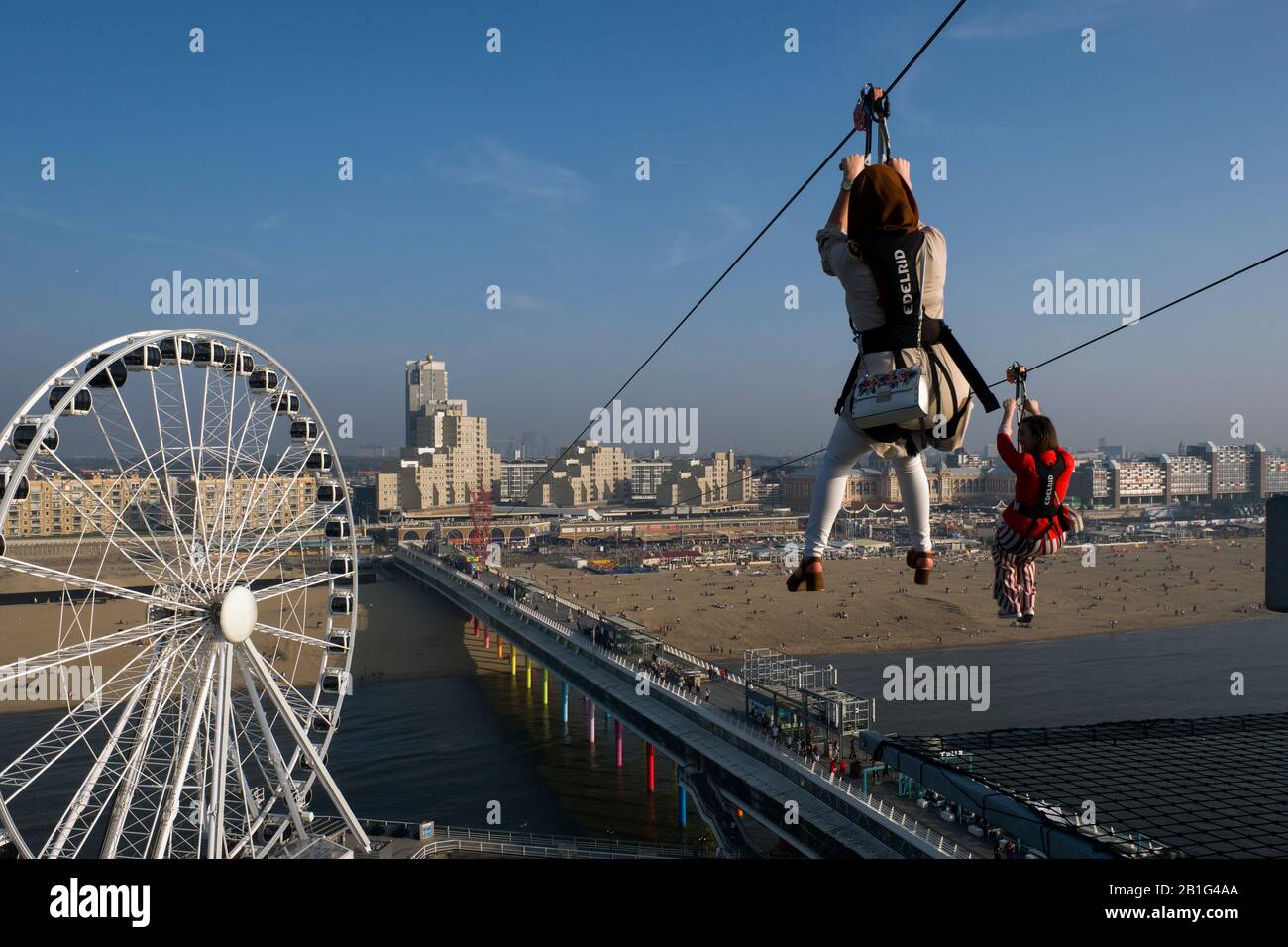 Two women slide down a zip line in one of the leisure centres located ...