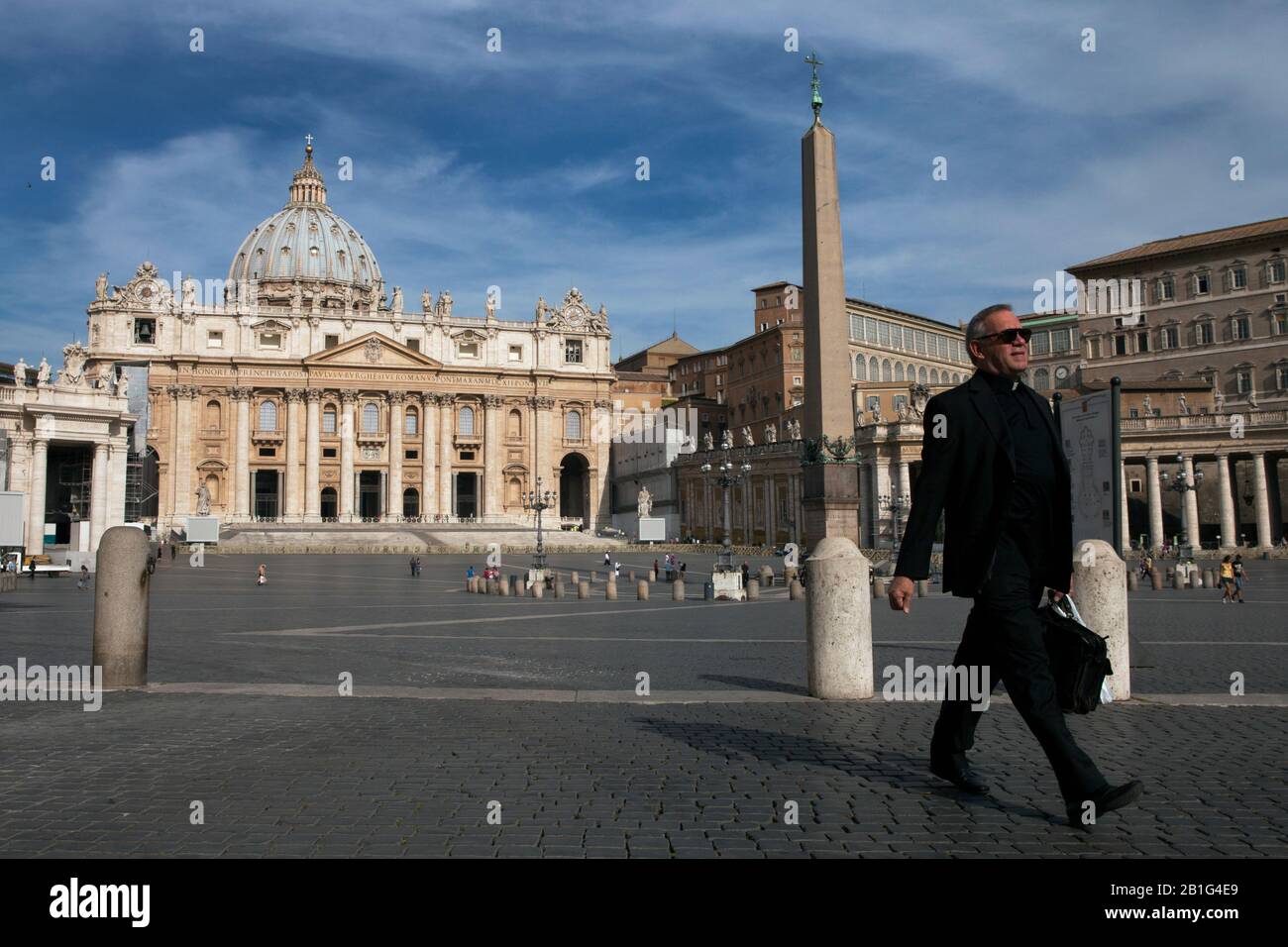 A priest walks through St. Peter's Square Stock Photo - Alamy