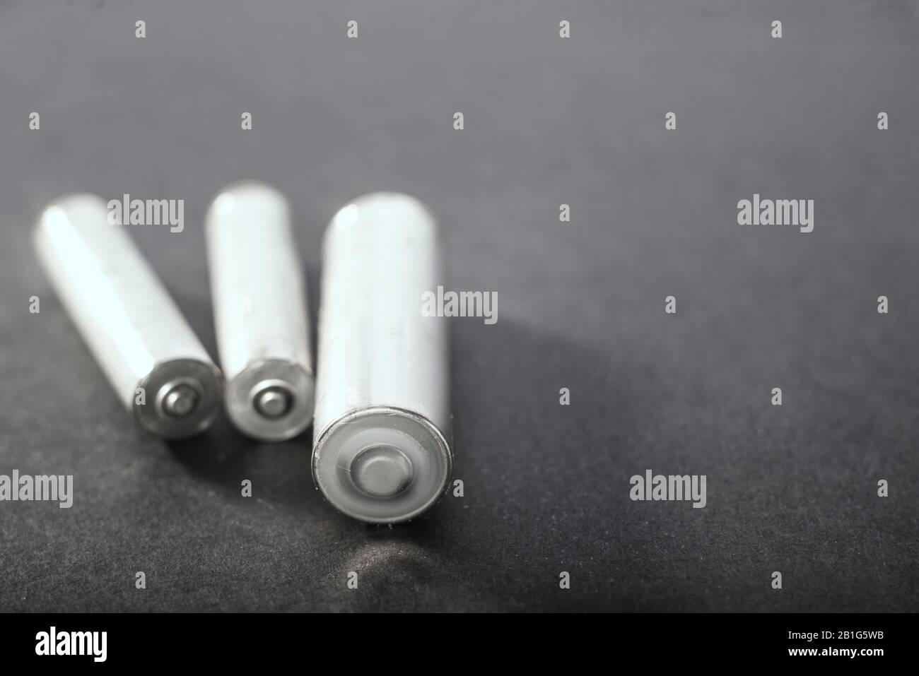 Used batteries, on a gray background. Environmental pollution by ...