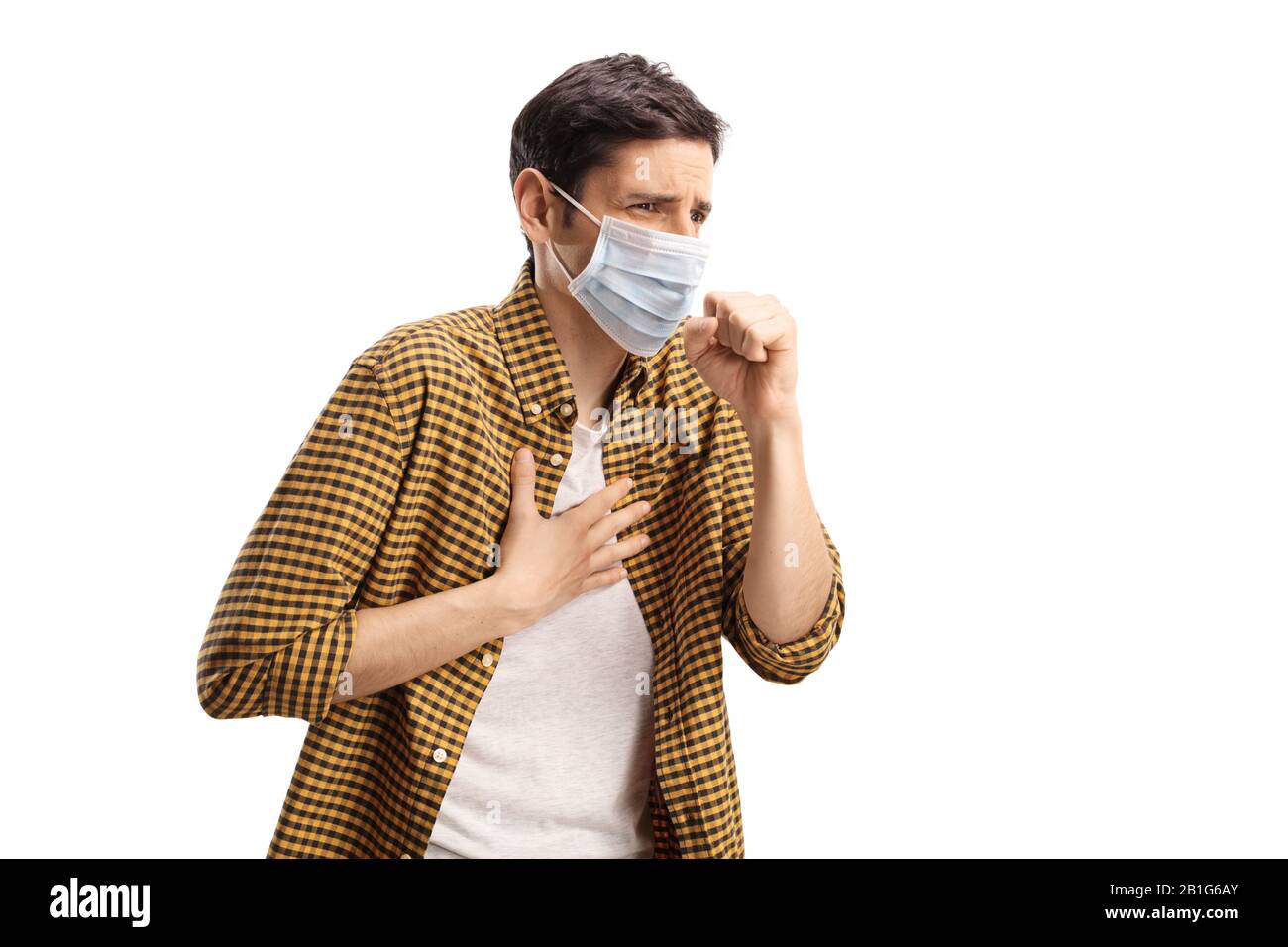 Young man coughing and wearing a face mask isolated on white background ...