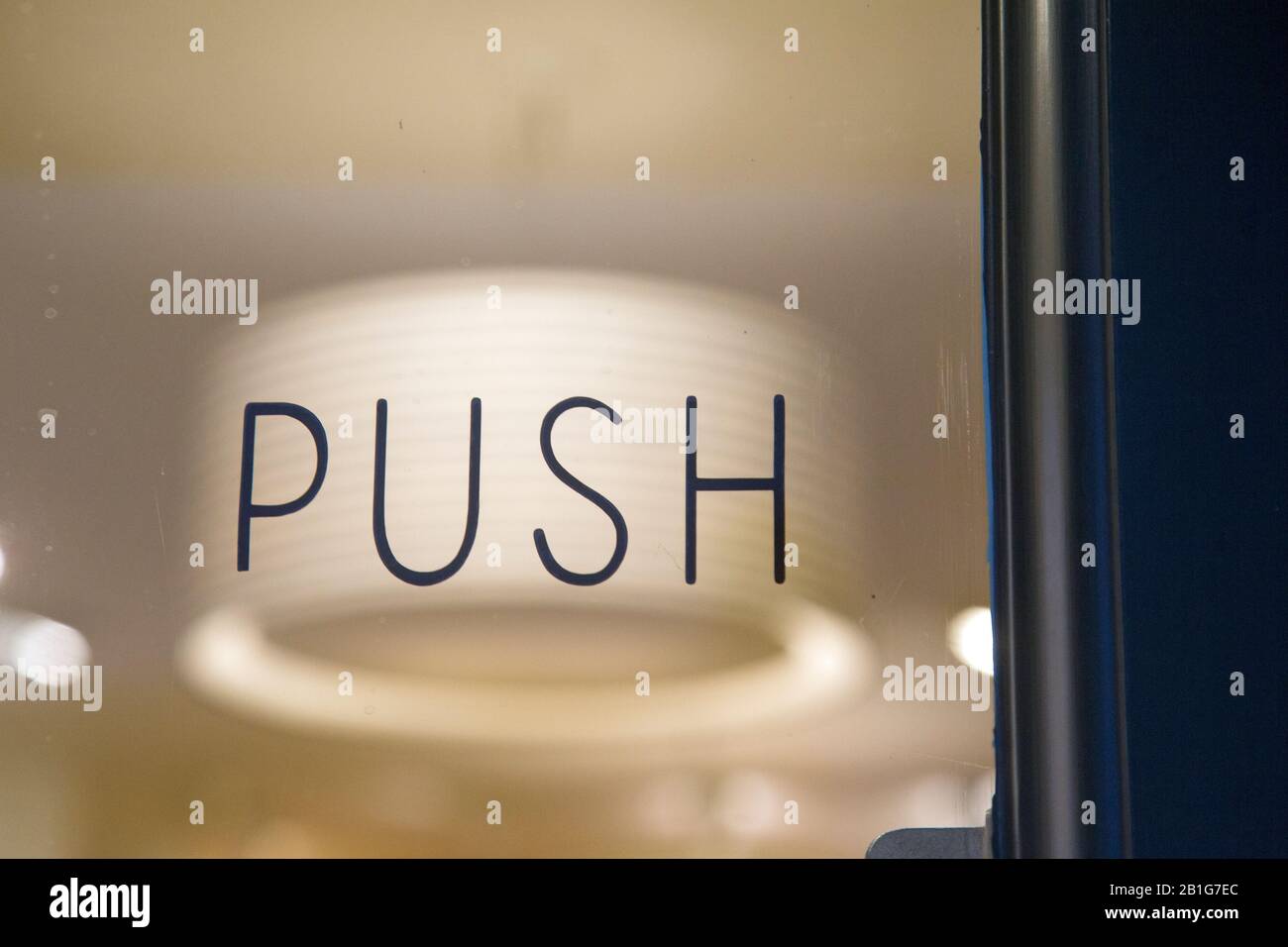 The word "Push" in black lettering set into a glass door Stock Photo ...