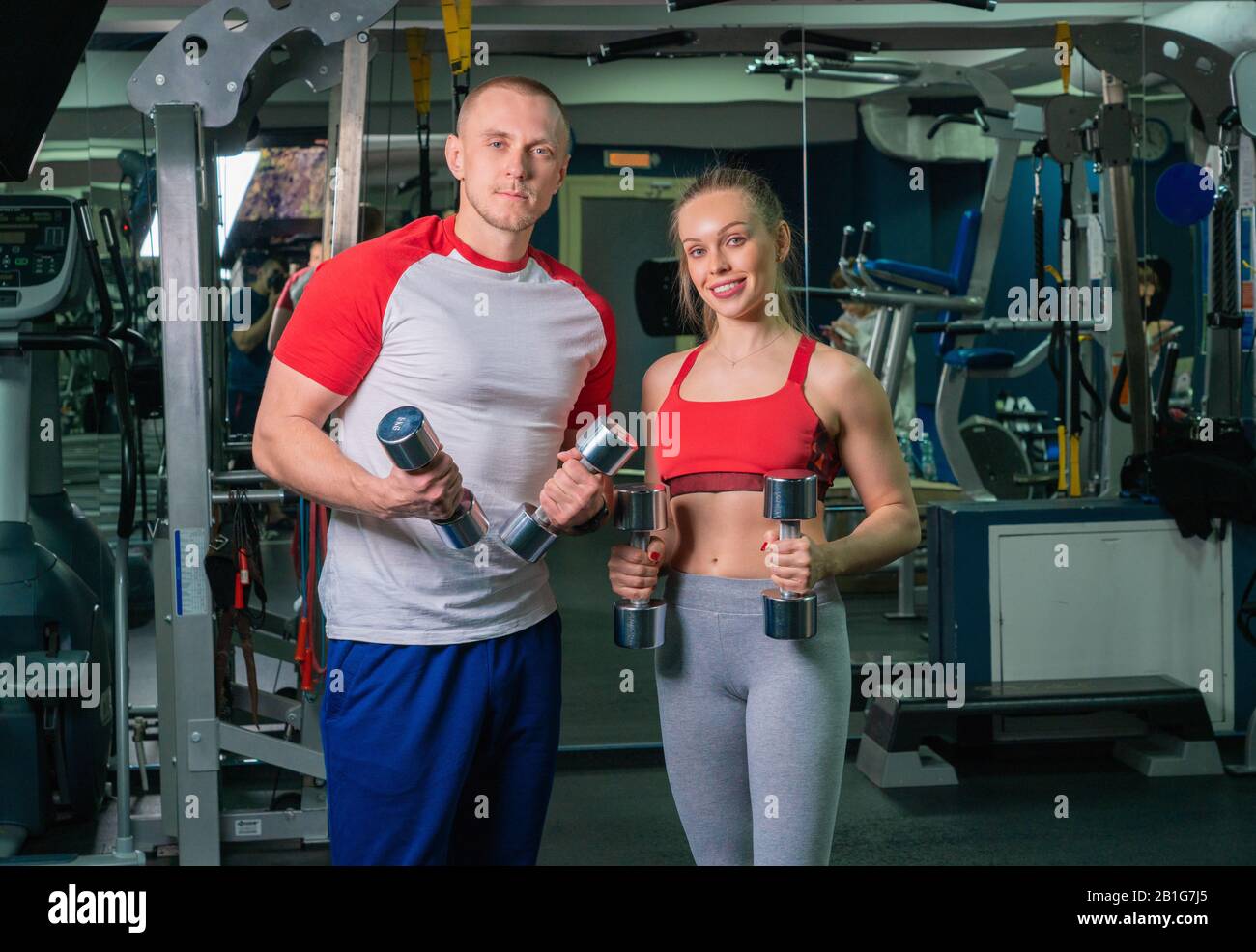 personal trainer man working with young woman in modern gym Stock Photo ...