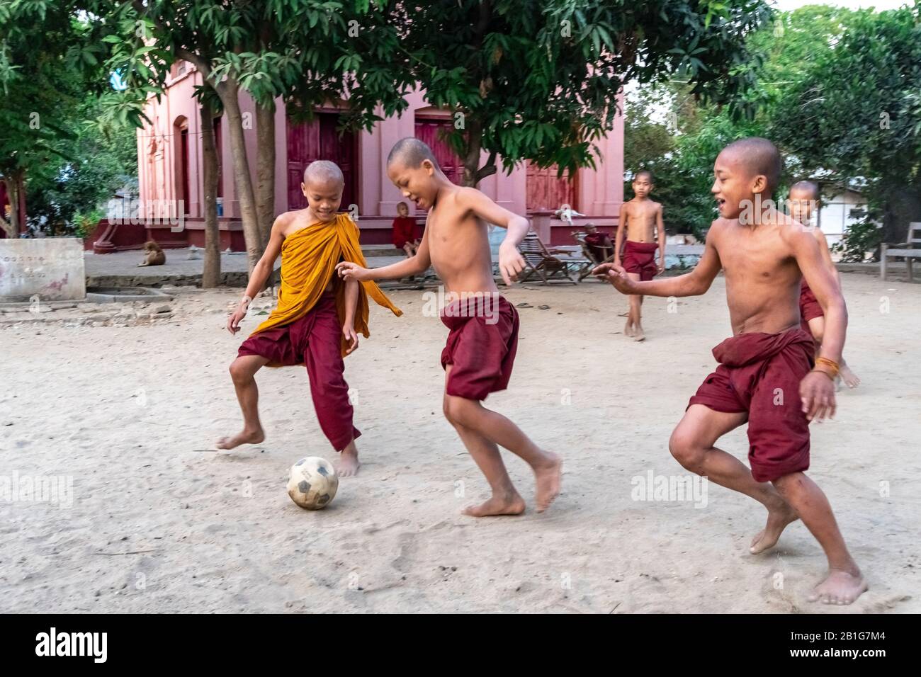Novice monks playing football at Buddhist monastery, Mingun, Mandalay ...