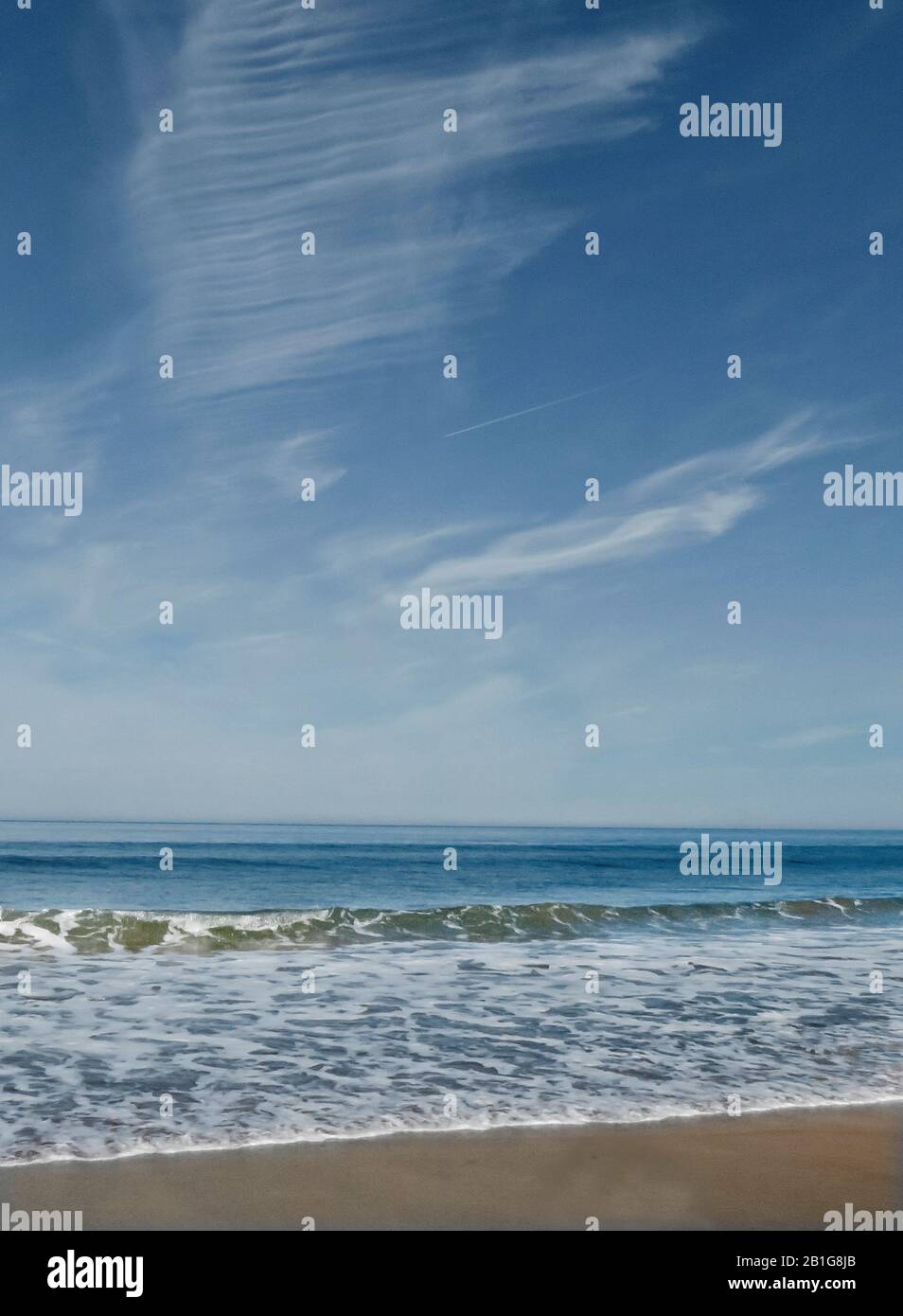 Colour photograph showing the wide expanse of the receding shallow ...