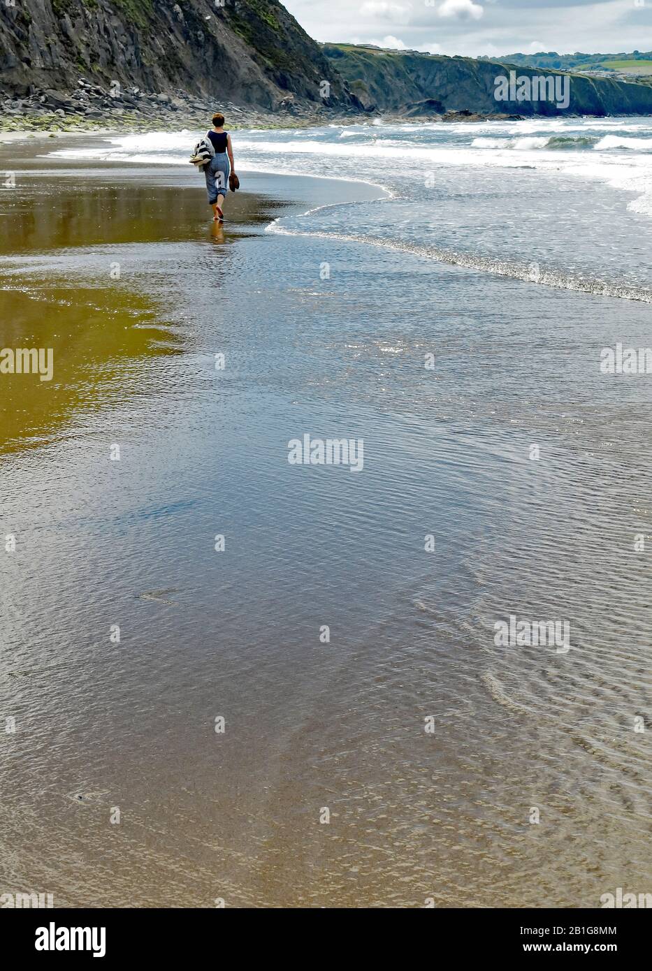 Colour photograph showing a person walking the wide expanse of the ...