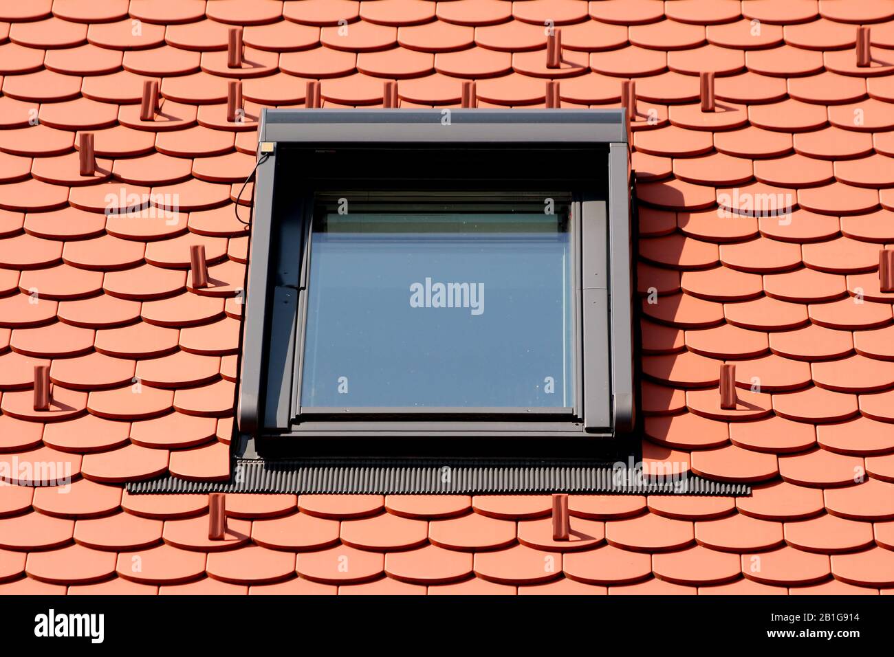 Modern new rectangle roof window with strong metal frame mounted on top ...