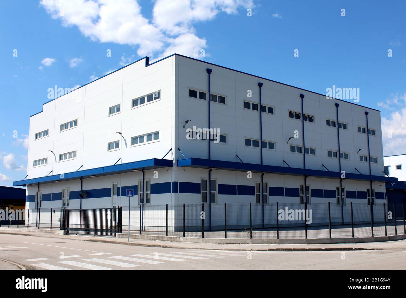 New white and blue industrial building with lower storage area and ...