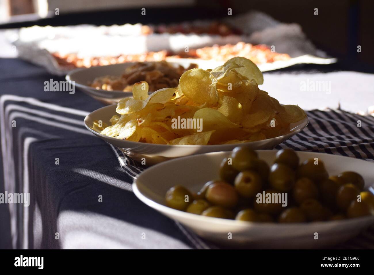 Spanish appetizer aperitif with crisps, olives and cookies among other ...