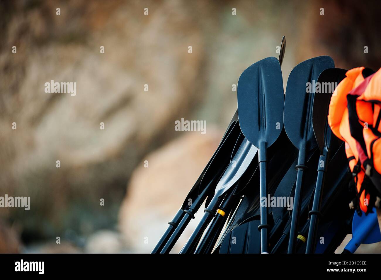 Several oars for a kayak on a cliff background. Kayak equipment Stock ...